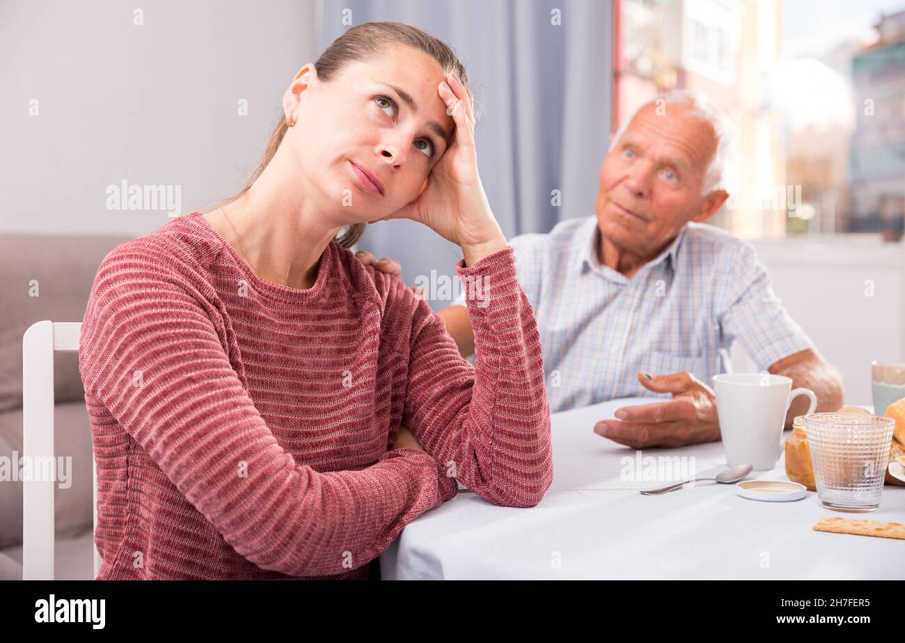 Portrait of upset young woman sitting after quarrel with father Stock ...