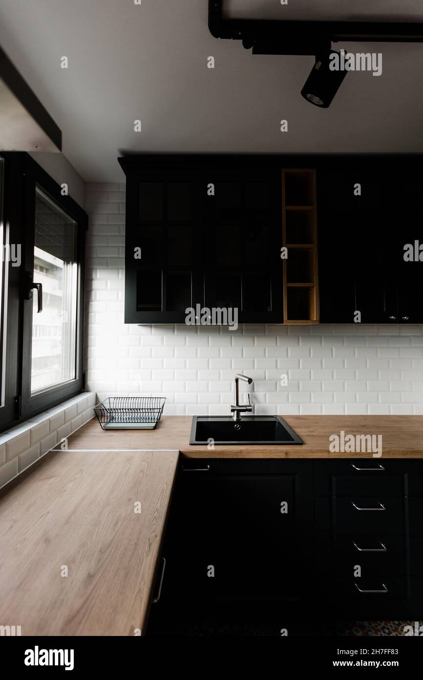 Vertical shot of a modern minimalistic kitchen with white brick tiles ...