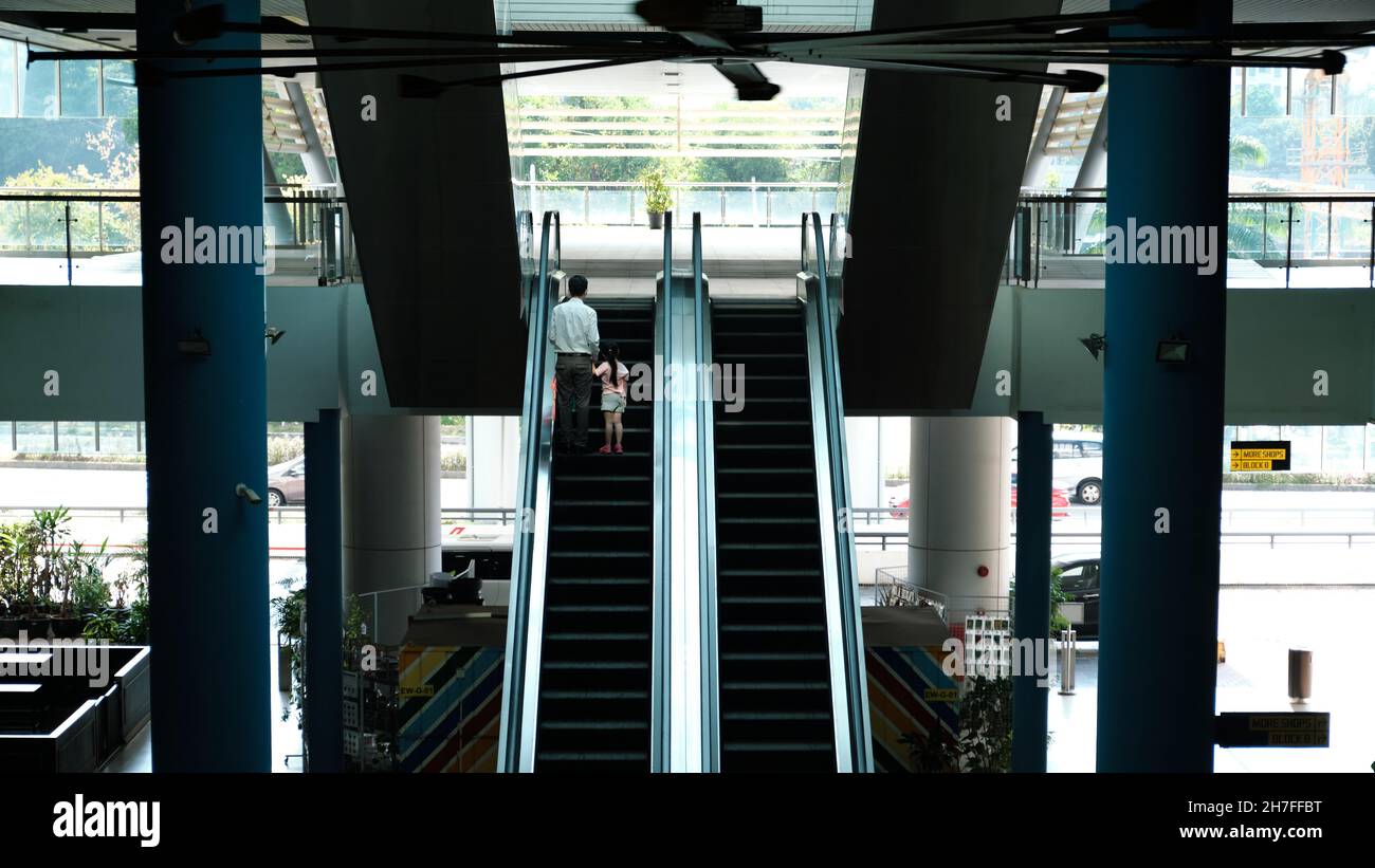 Modern escalators in a public office building with glass walls Stock ...