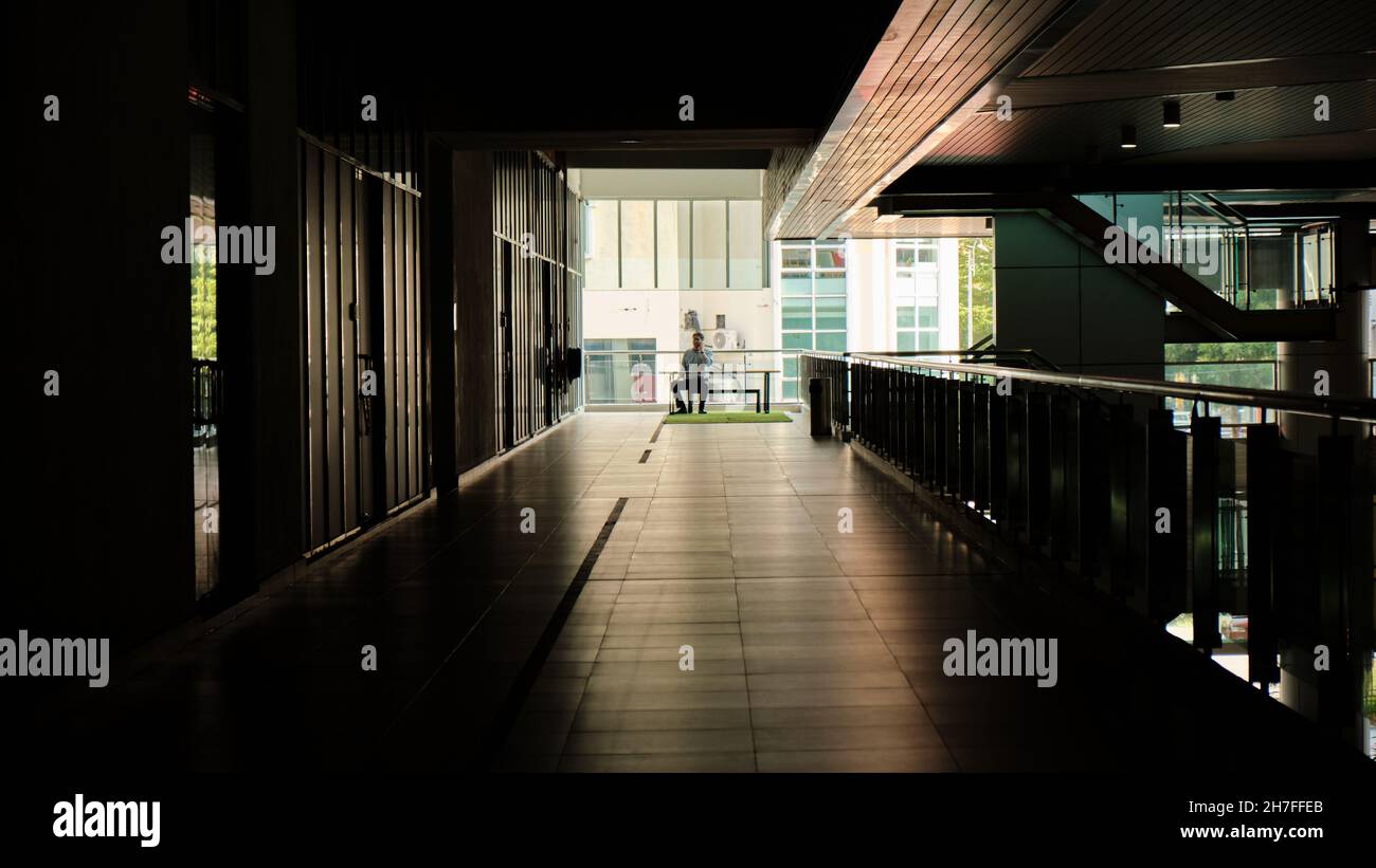 Dark hallway of a modern building with balconies on a sunny day Stock ...