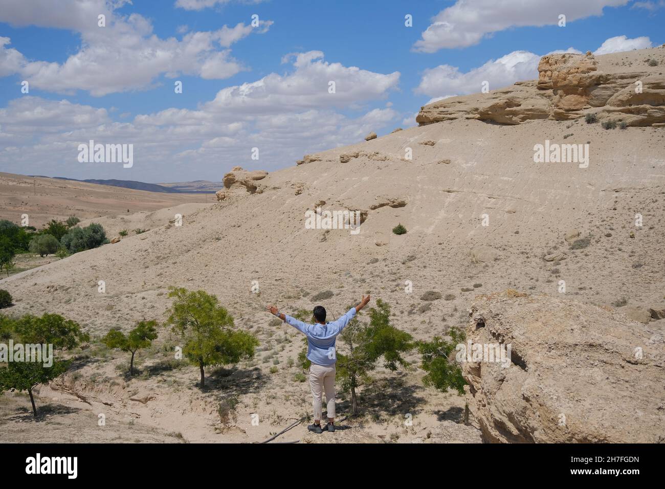 A man screaming to fairy chimneys in Kusca Turkey Konya. Desert geology ...