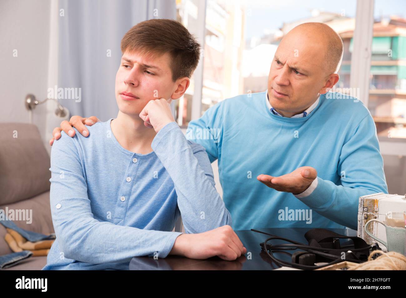 Father calming upset teenage son Stock Photo - Alamy