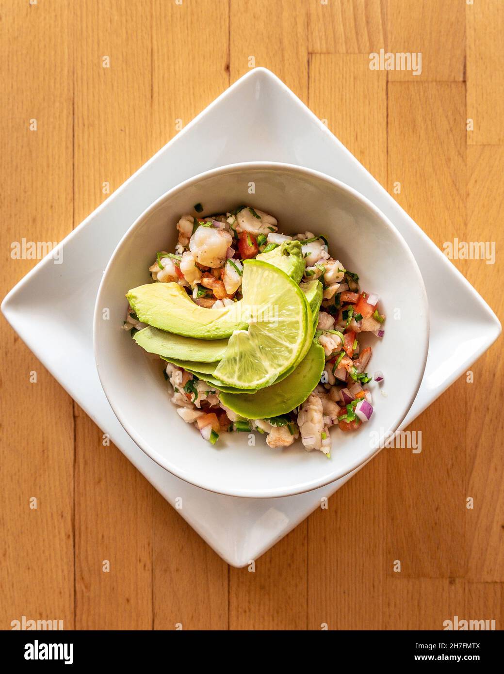 Top view of a bowl of seafood with lime and avocado Stock Photo - Alamy
