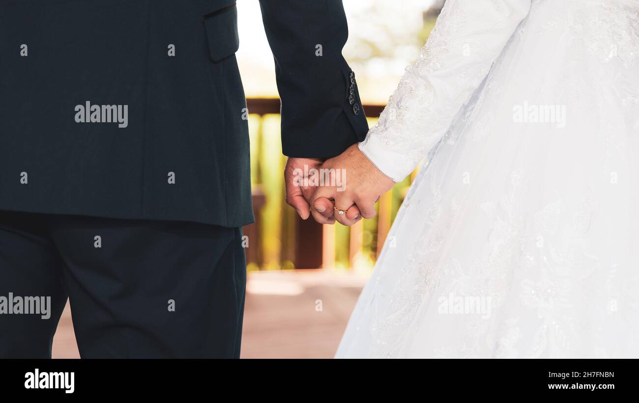 Newlyweds holding hands during a wedding ceremony Stock Photo - Alamy
