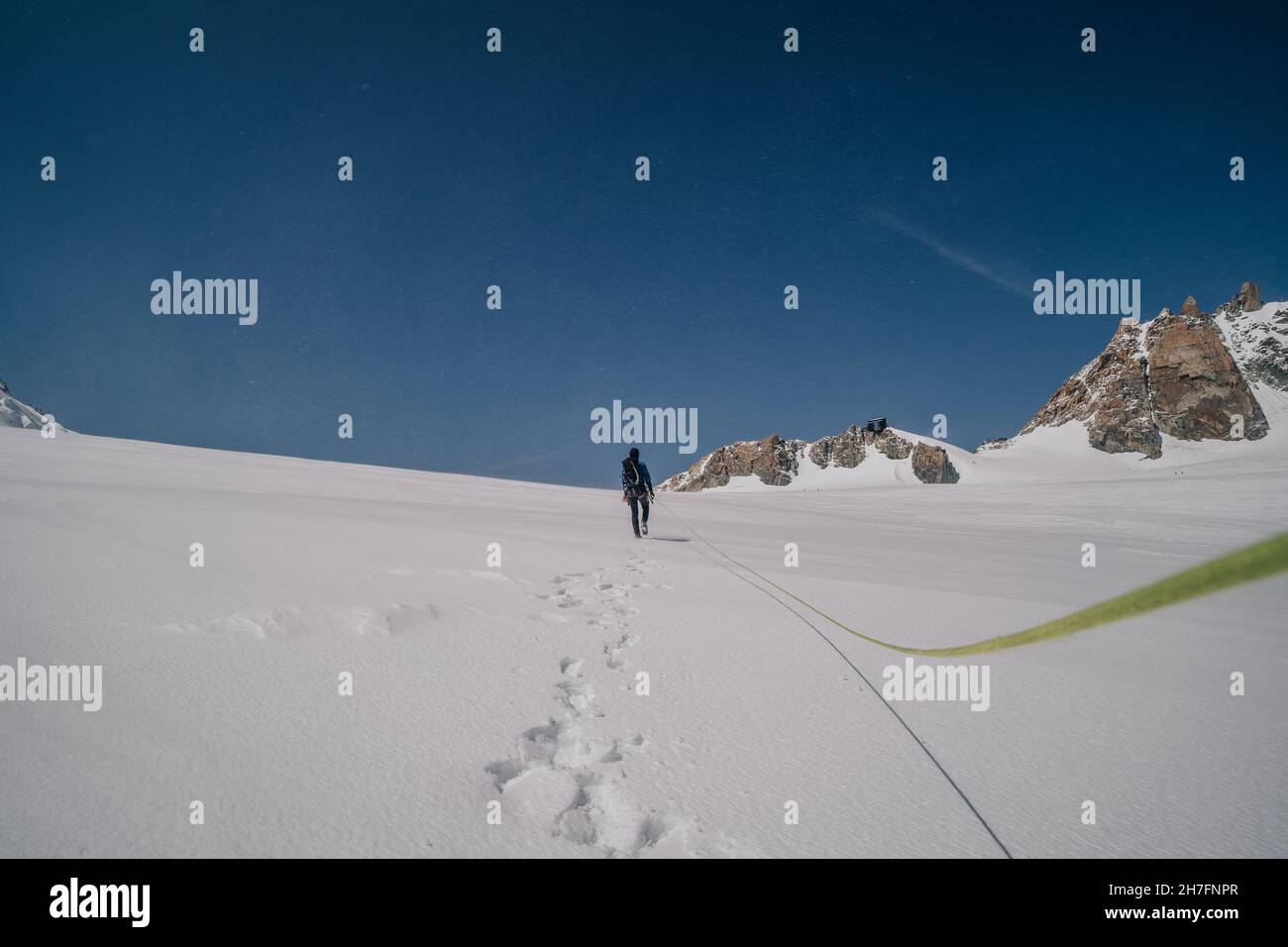 An Alpinist walking on a glacier Stock Photo - Alamy