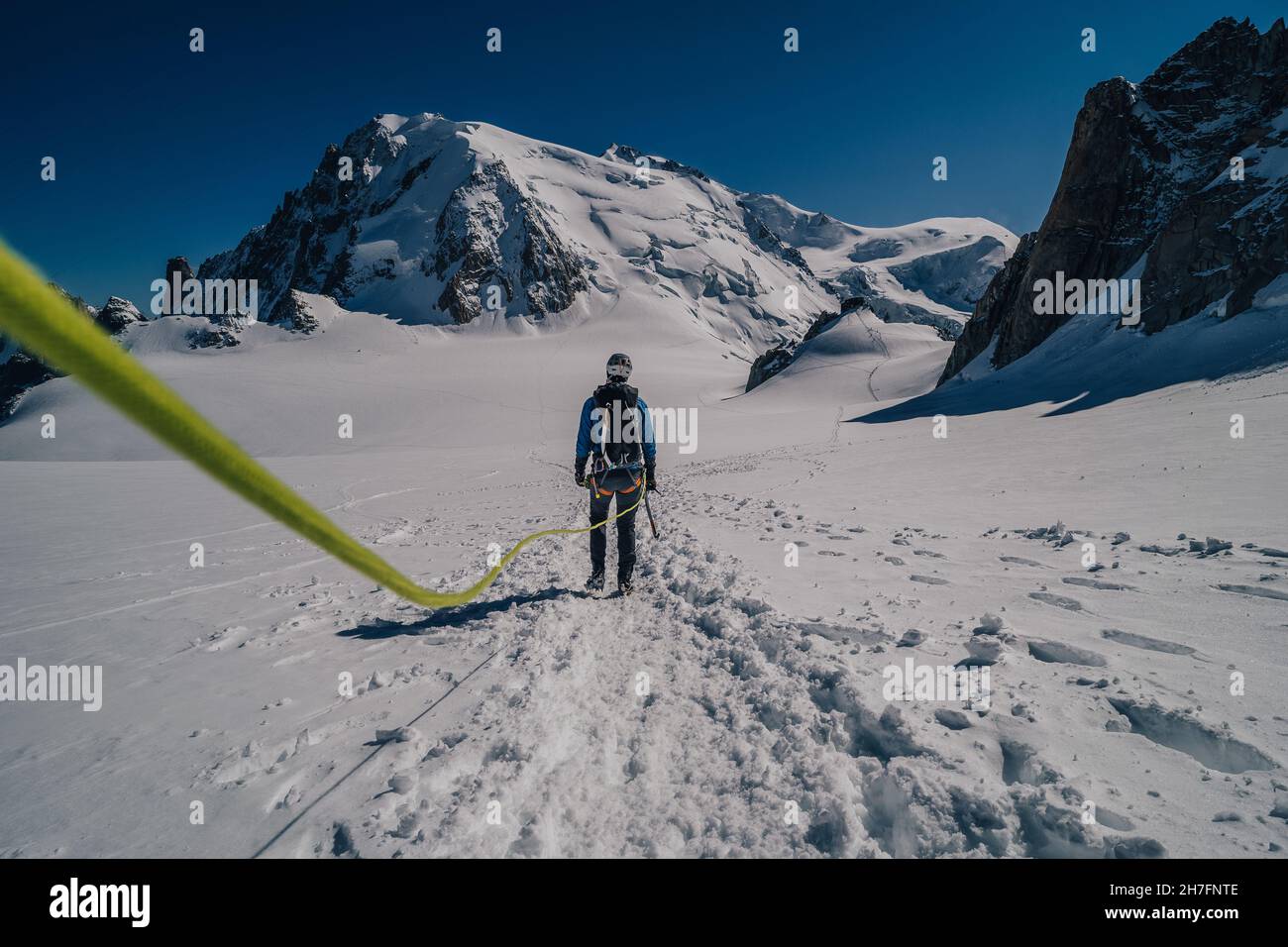 An Alpinist walking on a glacier Stock Photo - Alamy