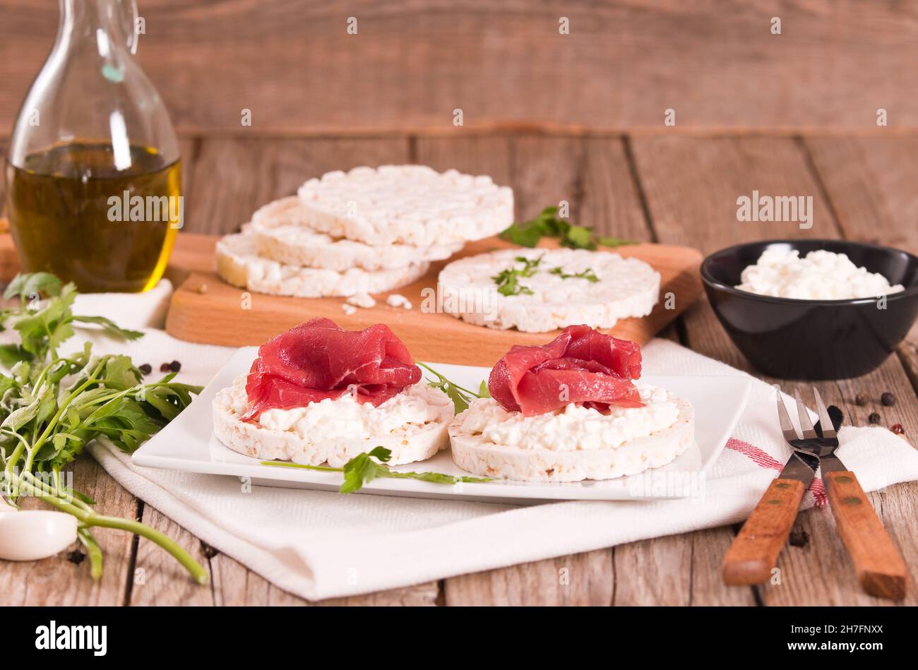 Rice cakes with milk flakes and cold beef Stock Photo - Alamy
