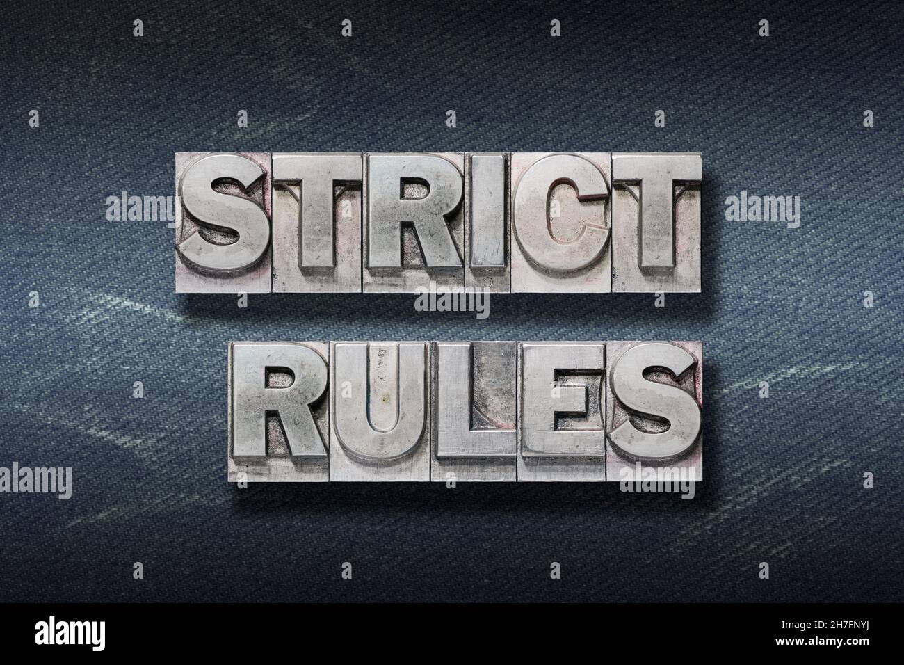 strict rules phrase made from metallic letterpress on dark jeans ...