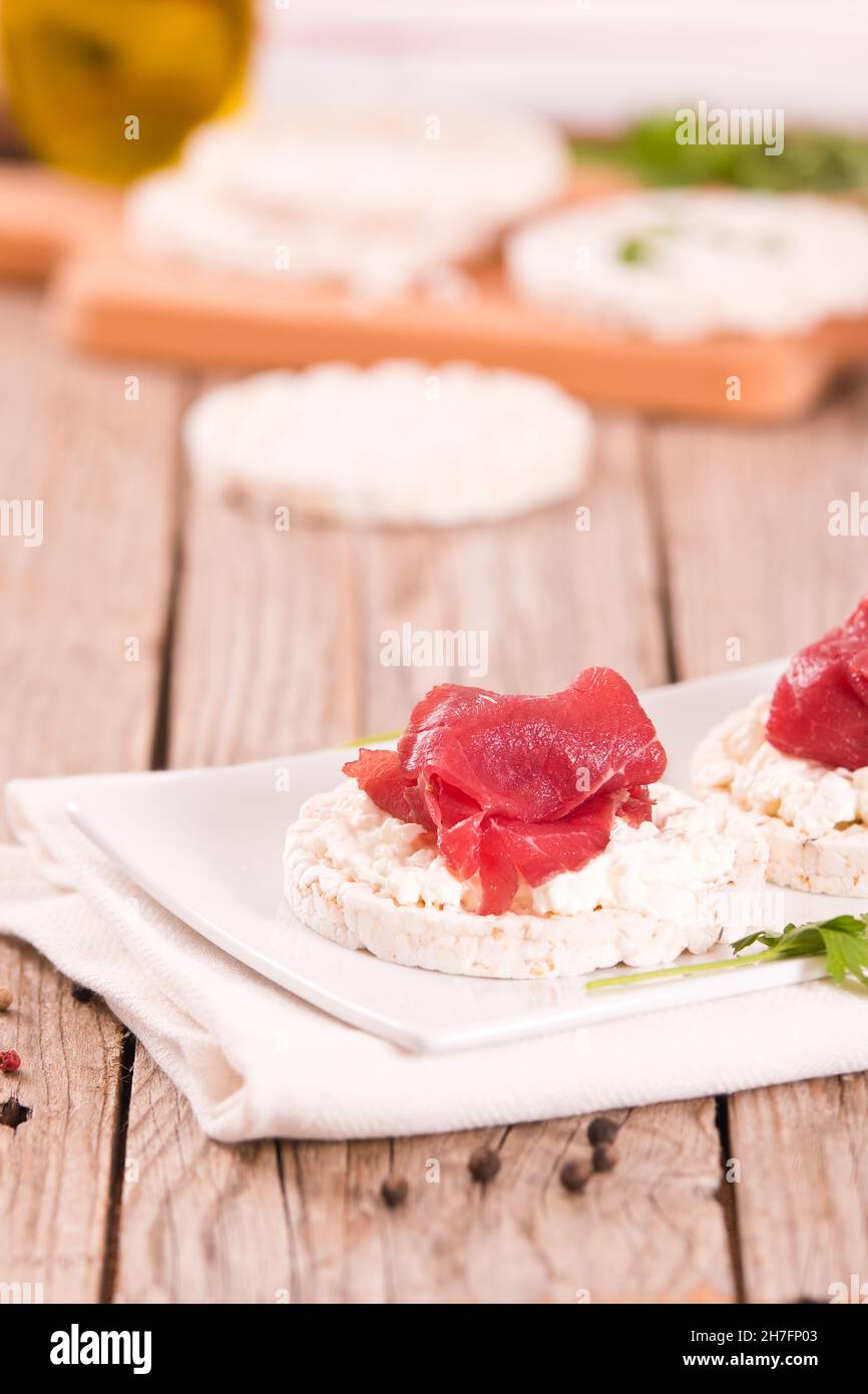 Rice cakes with milk flakes and cold beef Stock Photo - Alamy