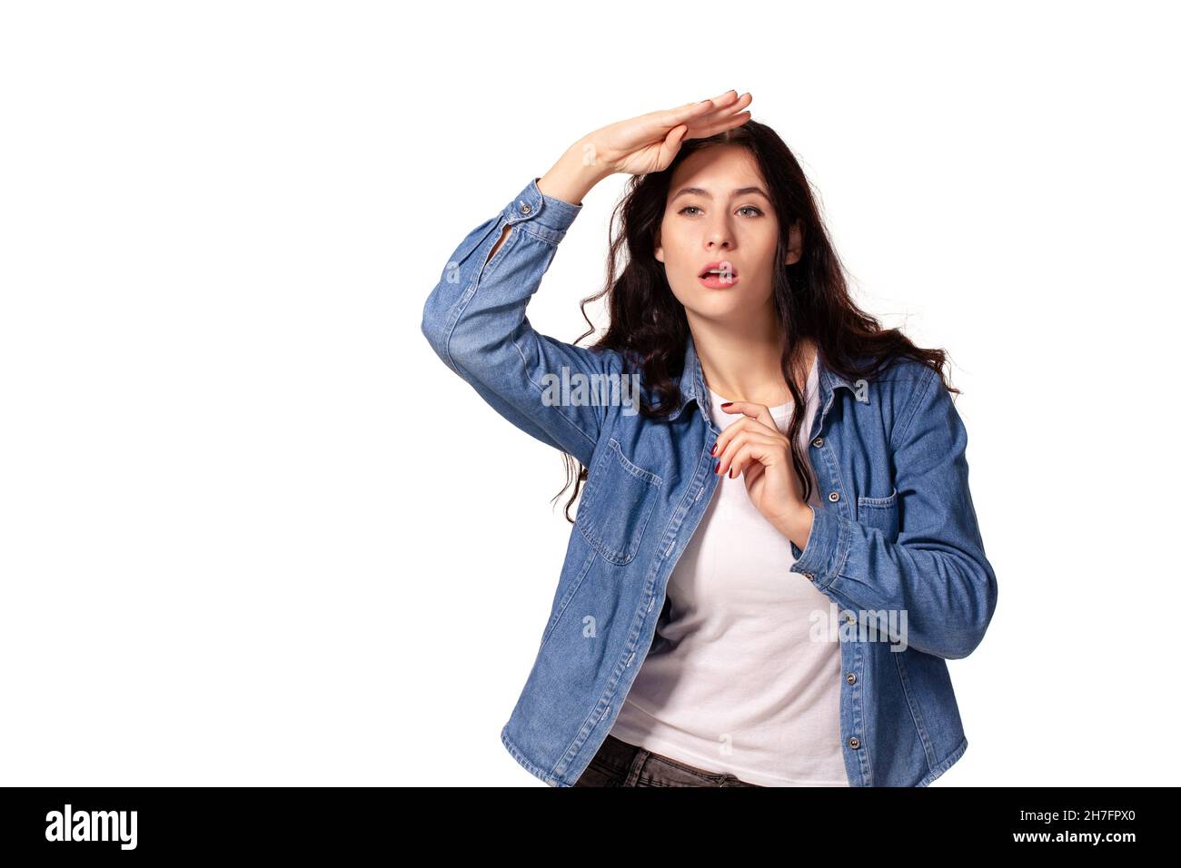 Serious woman looking forward and having put her palm to forehead Stock ...