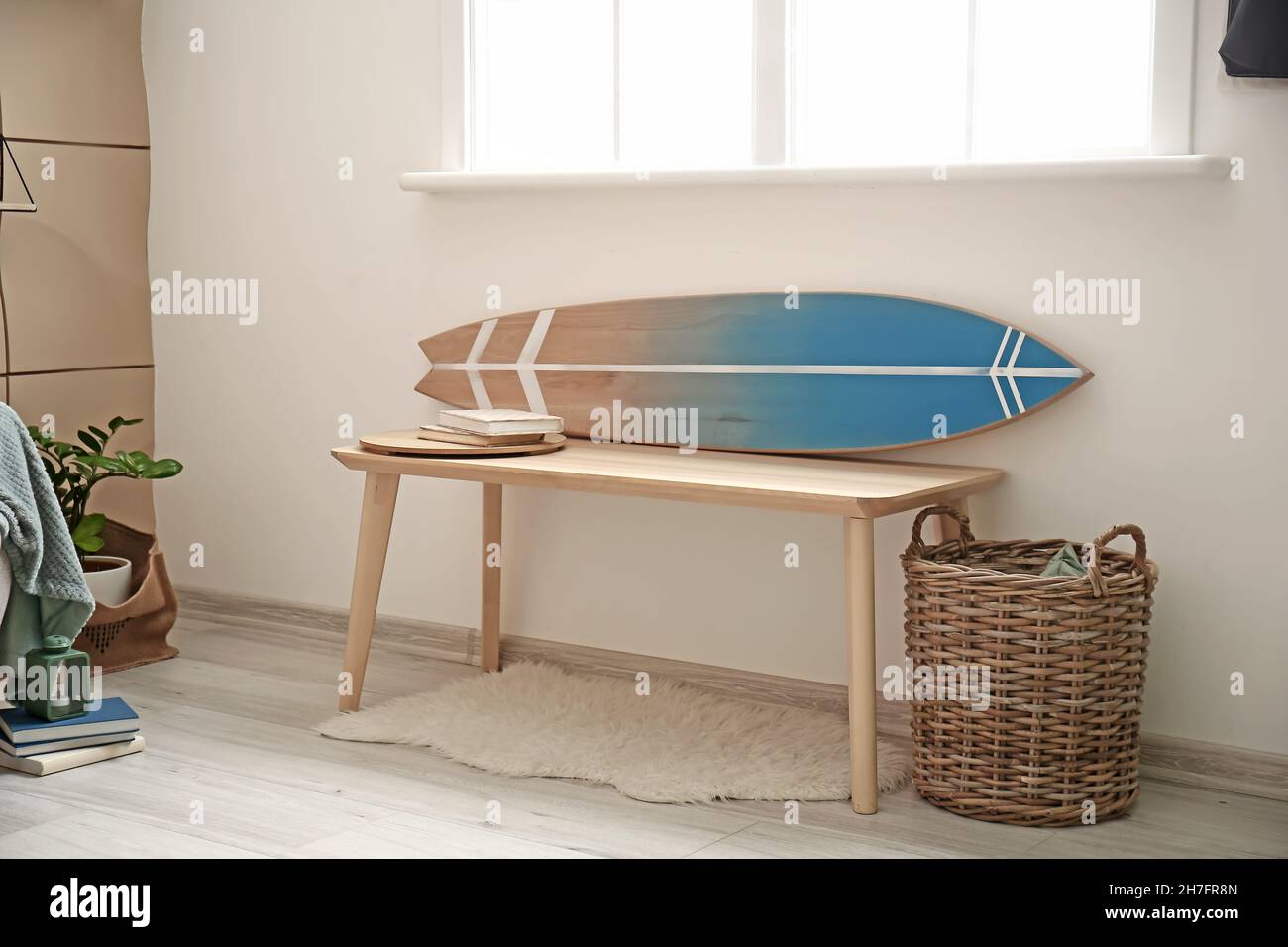 Bench with surfboard in interior of stylish modern room Stock Photo - Alamy