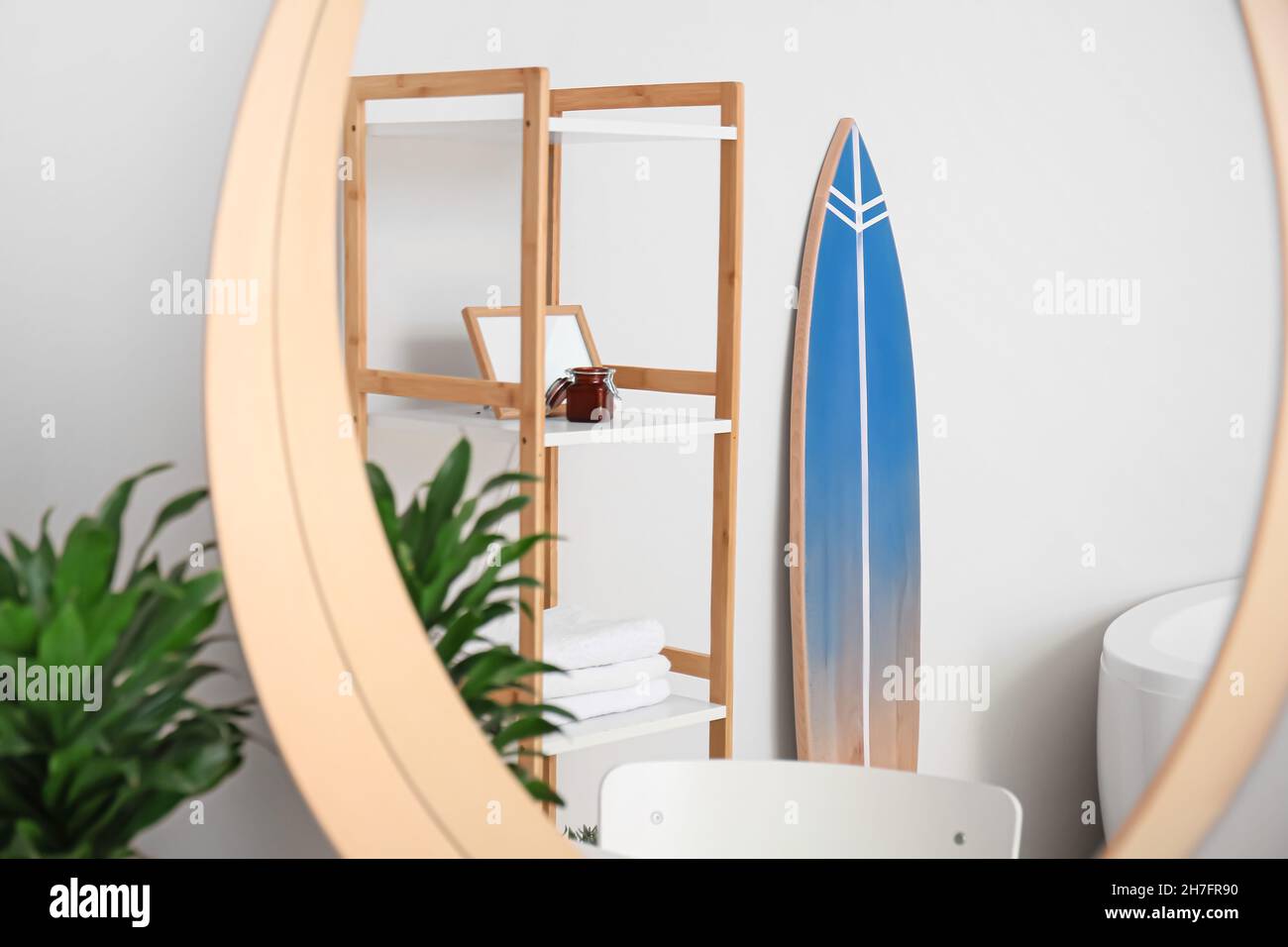 Interior of stylish bathroom with surfboard and mirror Stock Photo - Alamy