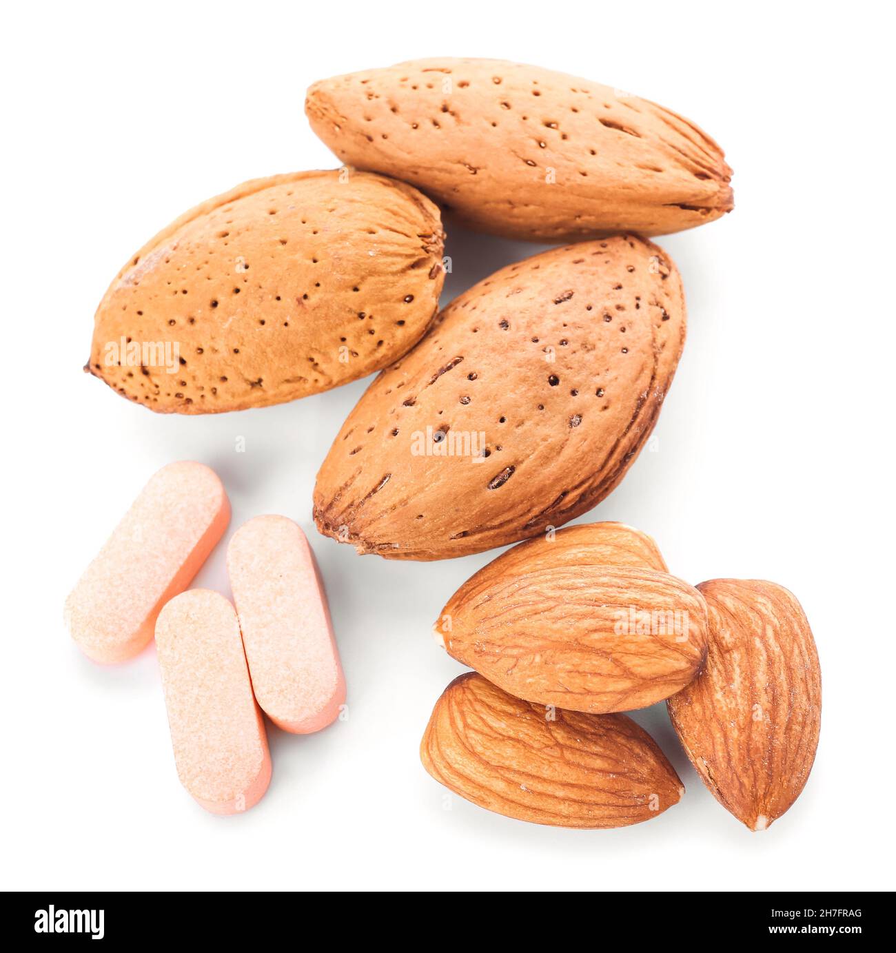Almond nuts and pills on white background Stock Photo - Alamy