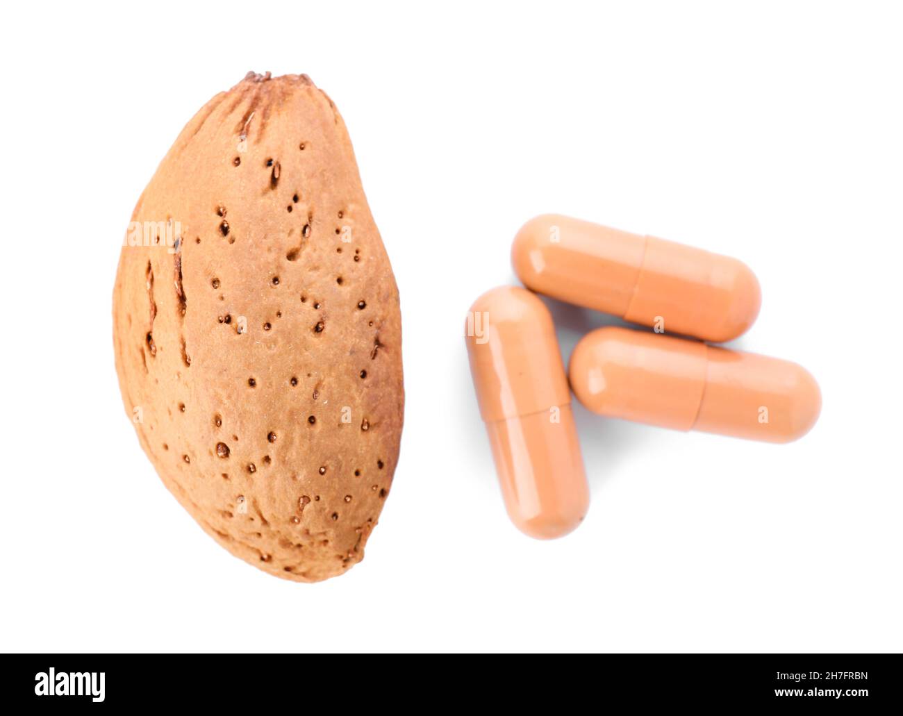 Almond nut with pills on white background Stock Photo - Alamy