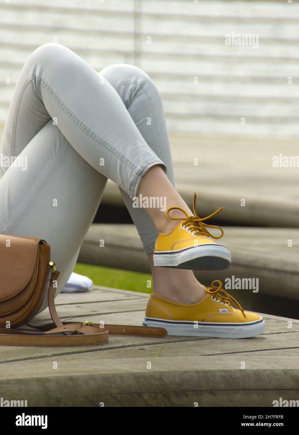 Recreation in the city - Legs crossed over each other Stock Photo - Alamy