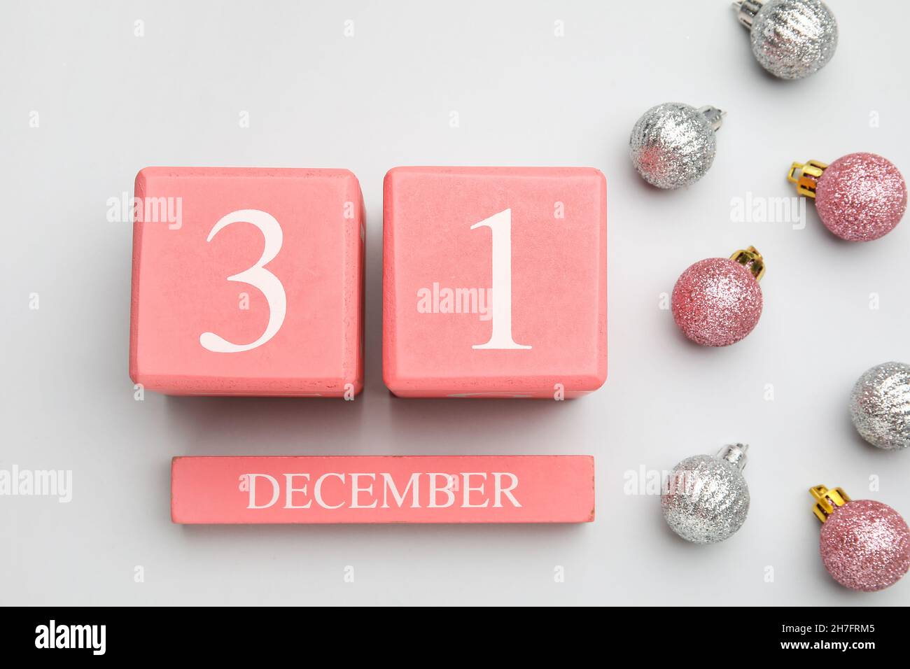 Calendar with date of New Year and Christmas balls on white background ...