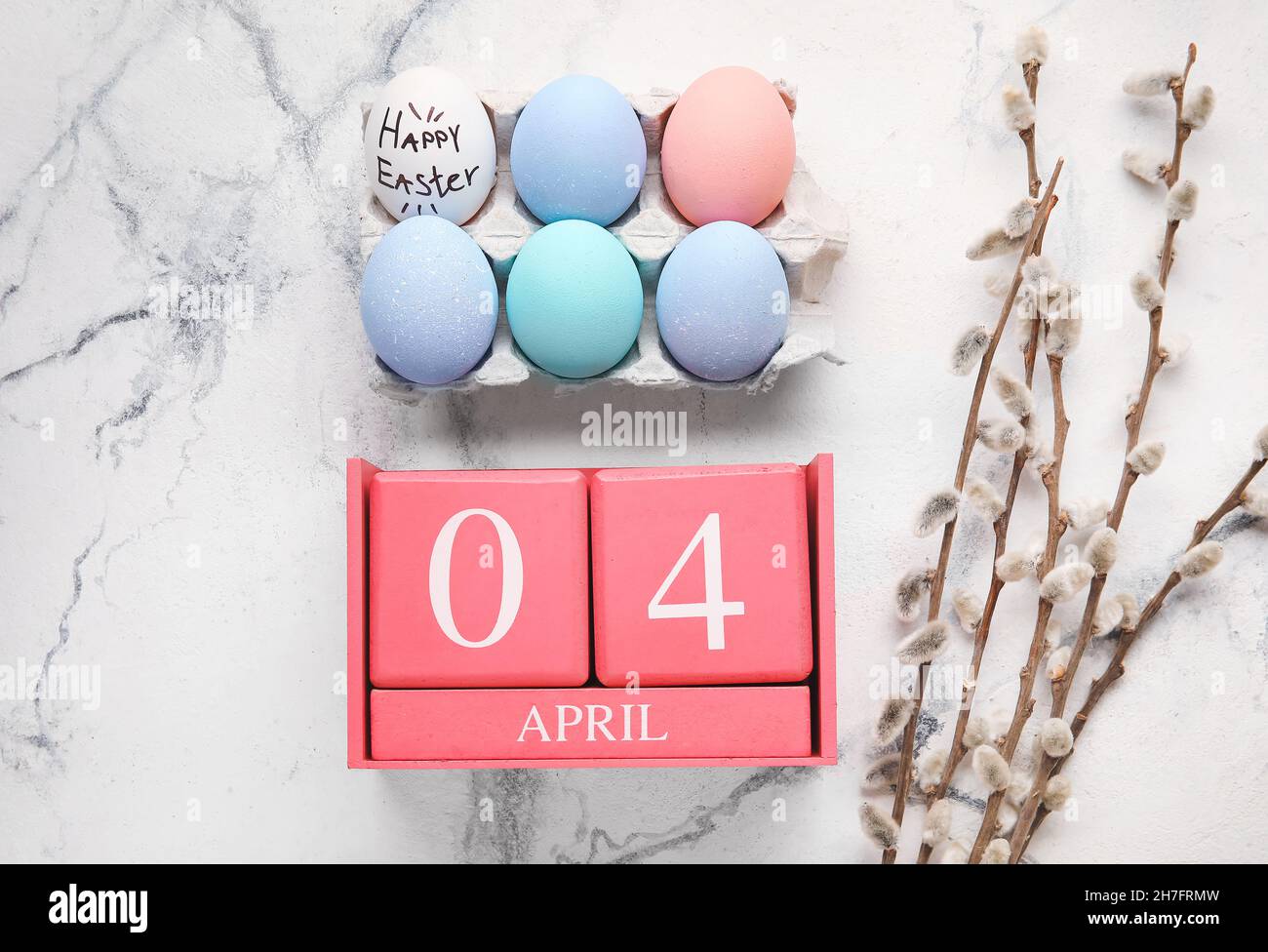 Calendar with date of April 4, painted eggs and willow branches on ...