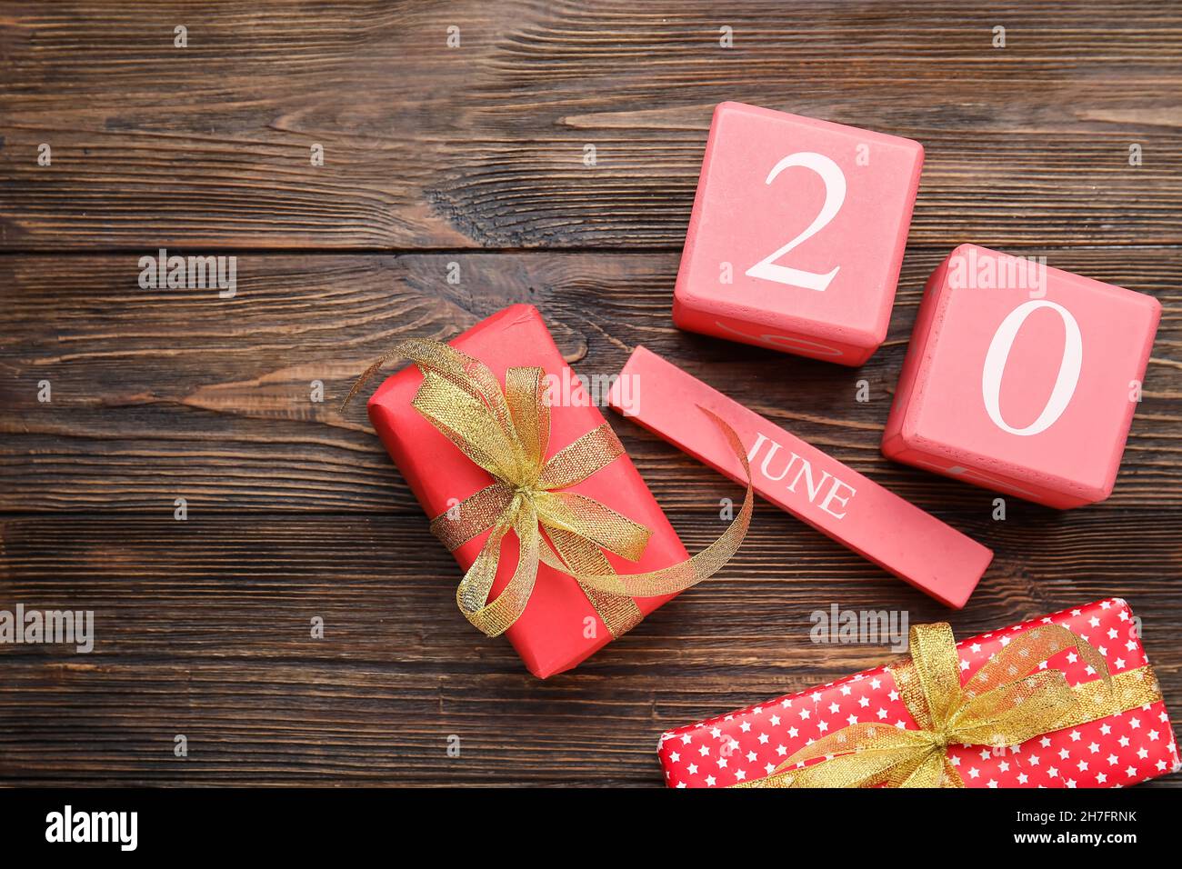 Calendar with date of June 20 and gift boxes on wooden background Stock ...