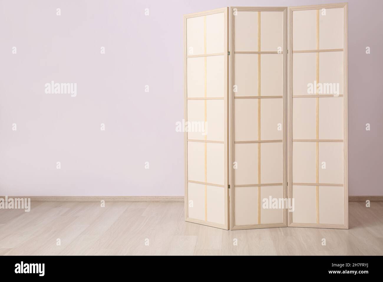 Stylish folding screen in room interior on wall background Stock Photo ...