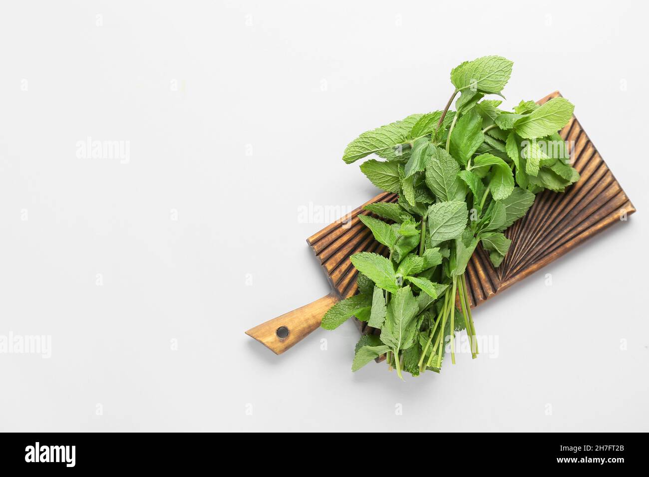 Wooden board with fresh mint on white background Stock Photo - Alamy