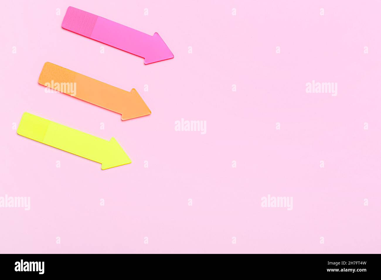 Colorful sticky notes in shape of arrows on pink background Stock Photo ...