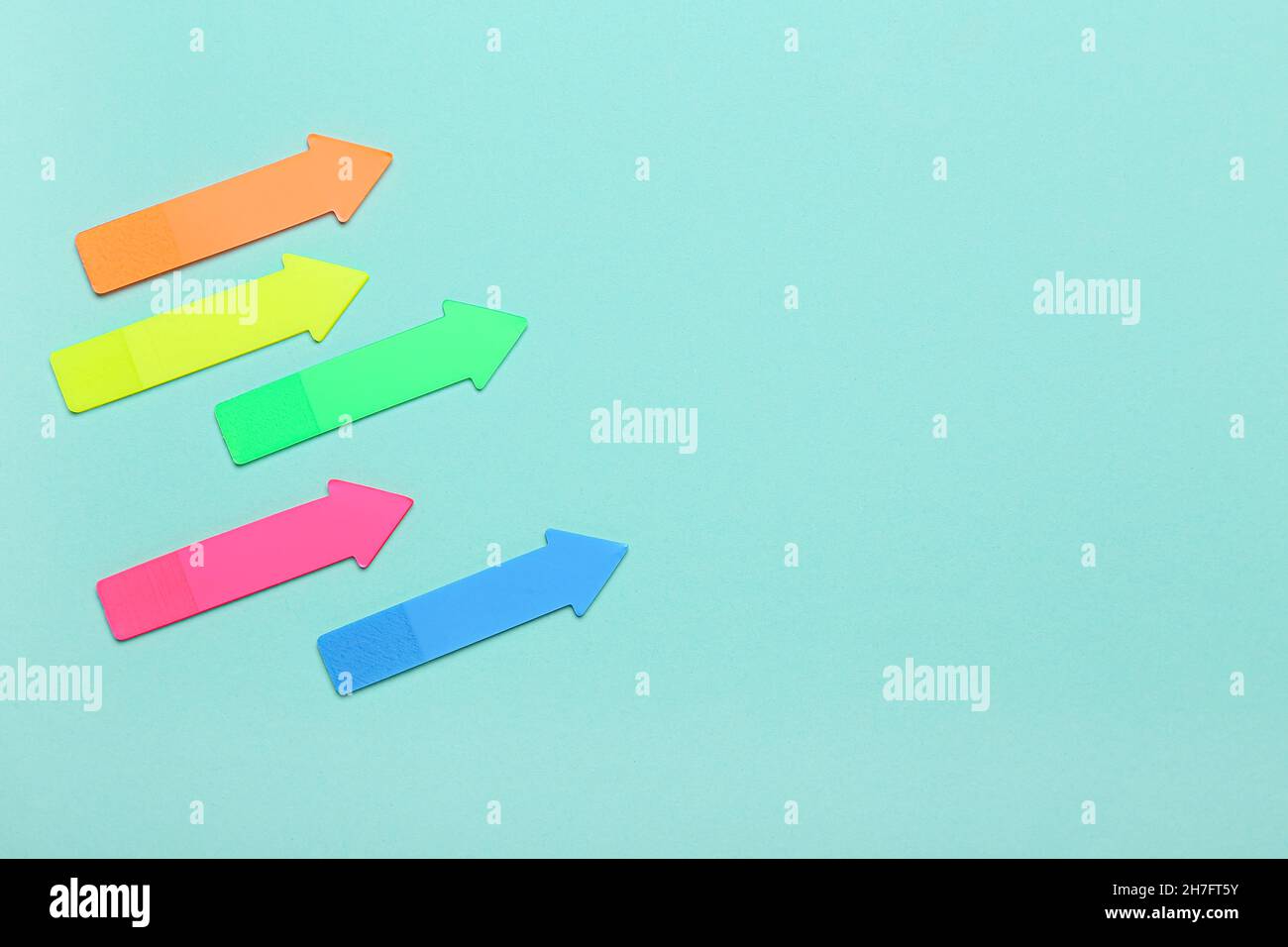 Sticky notes in shape of arrows on blue background Stock Photo - Alamy