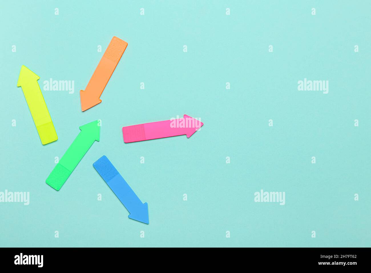 Sticky notes in shape of arrows on blue background Stock Photo - Alamy