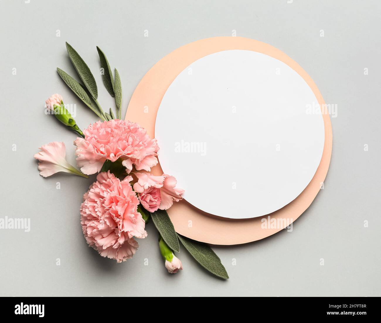 Composition with flowers and blank card on grey background Stock Photo ...