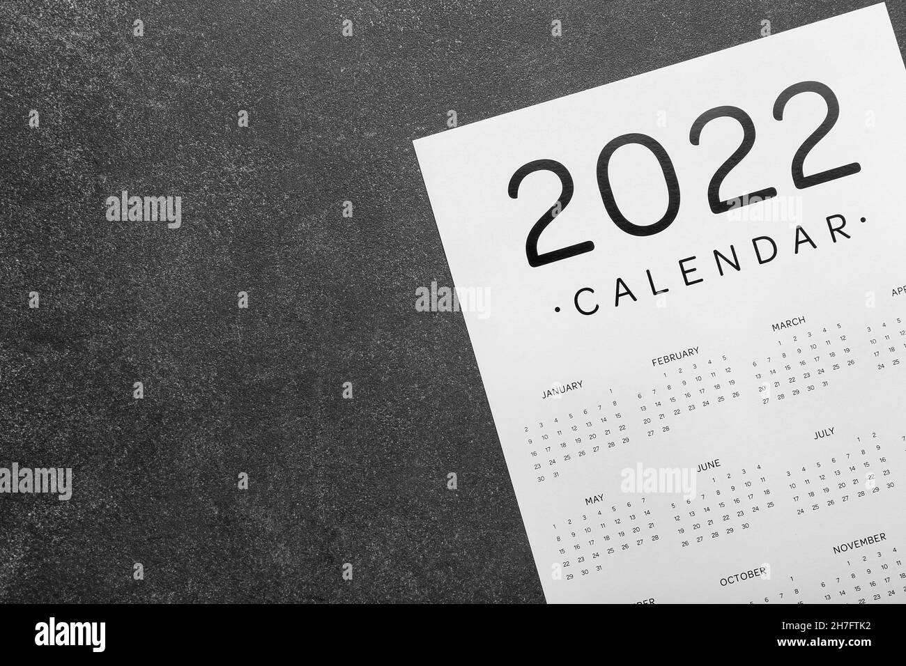 Paper calendar for year 2022 on dark background Stock Photo - Alamy