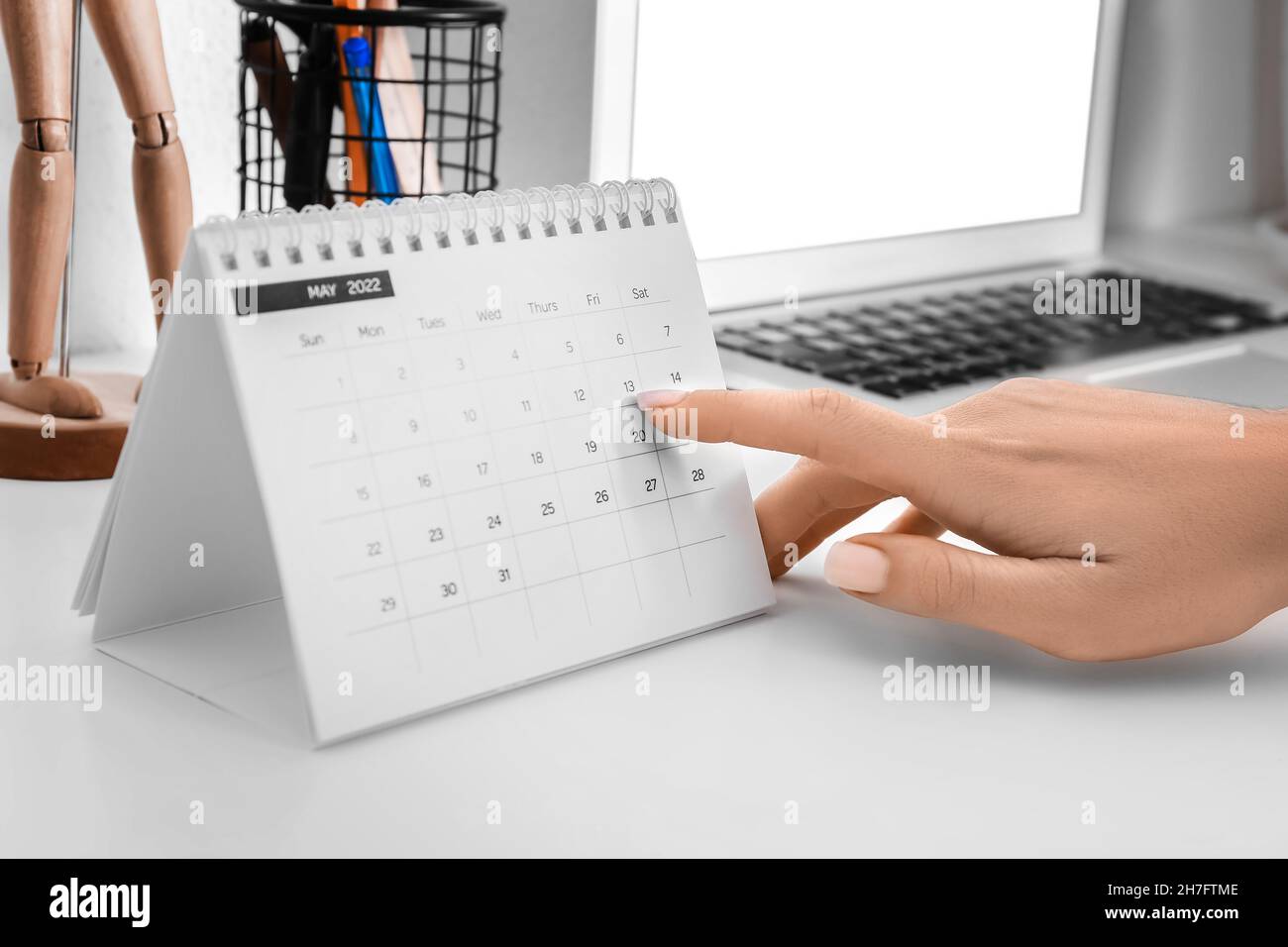 Woman with flip calendar at workplace Stock Photo - Alamy