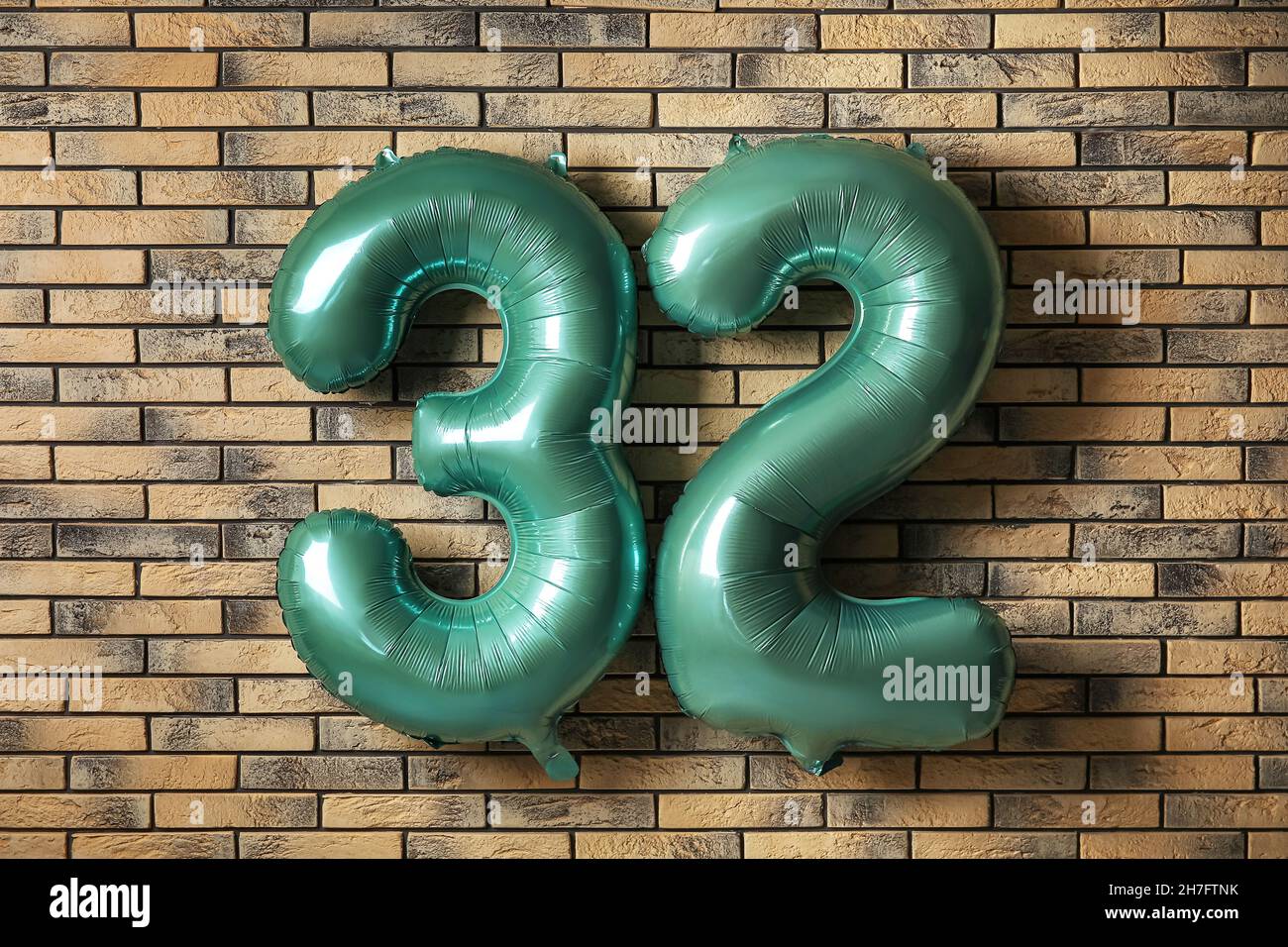 Number 32 made of balloons on brick background Stock Photo - Alamy