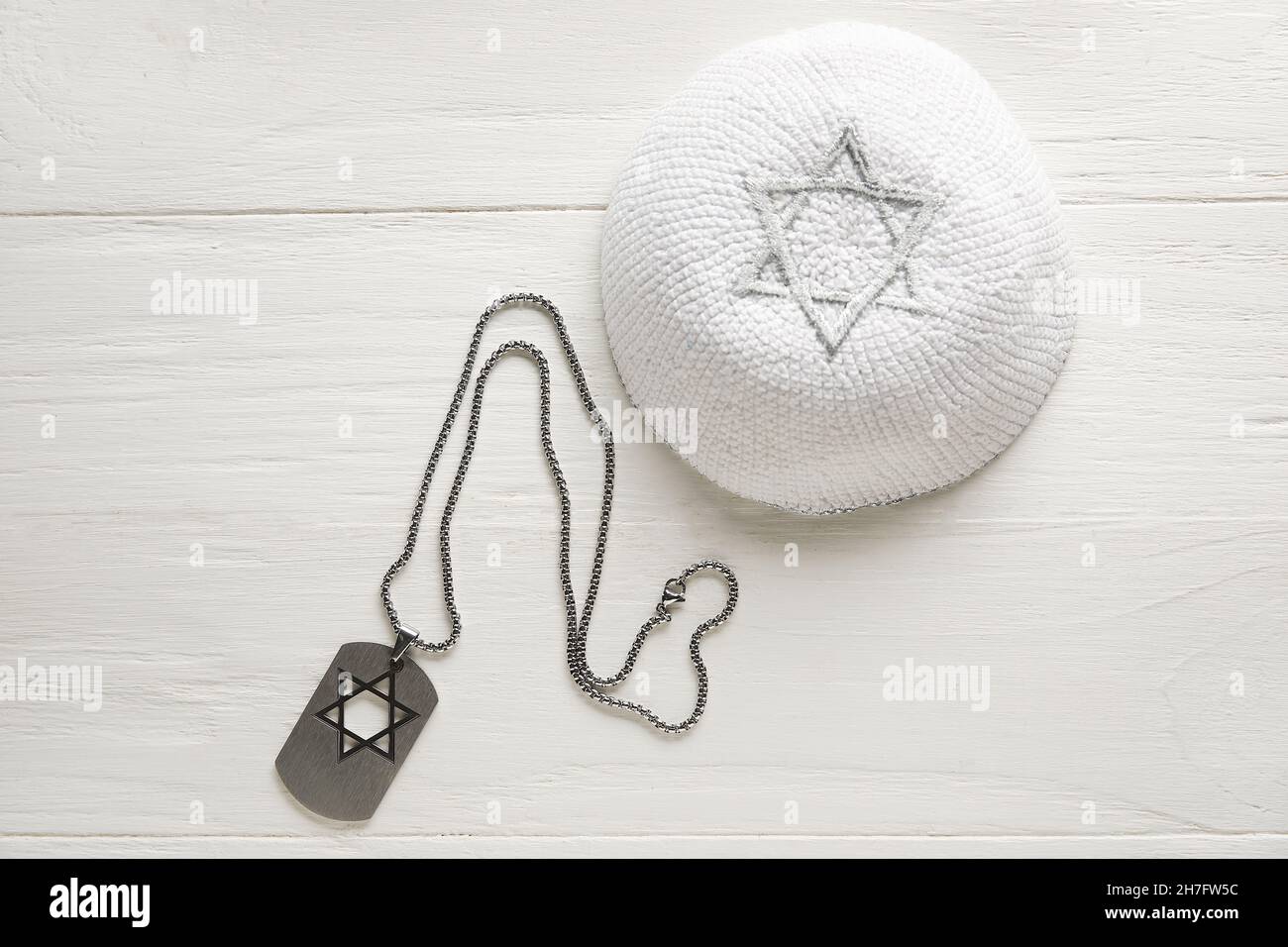 Dog tag of Israeli soldier and kippah on white wooden background Stock ...