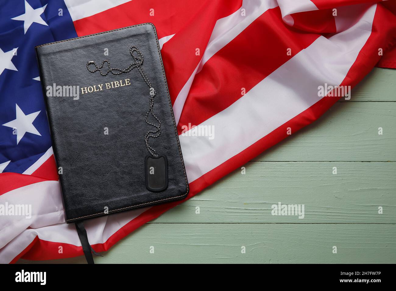 Bible, military tag and flag of USA on wooden background Stock Photo ...