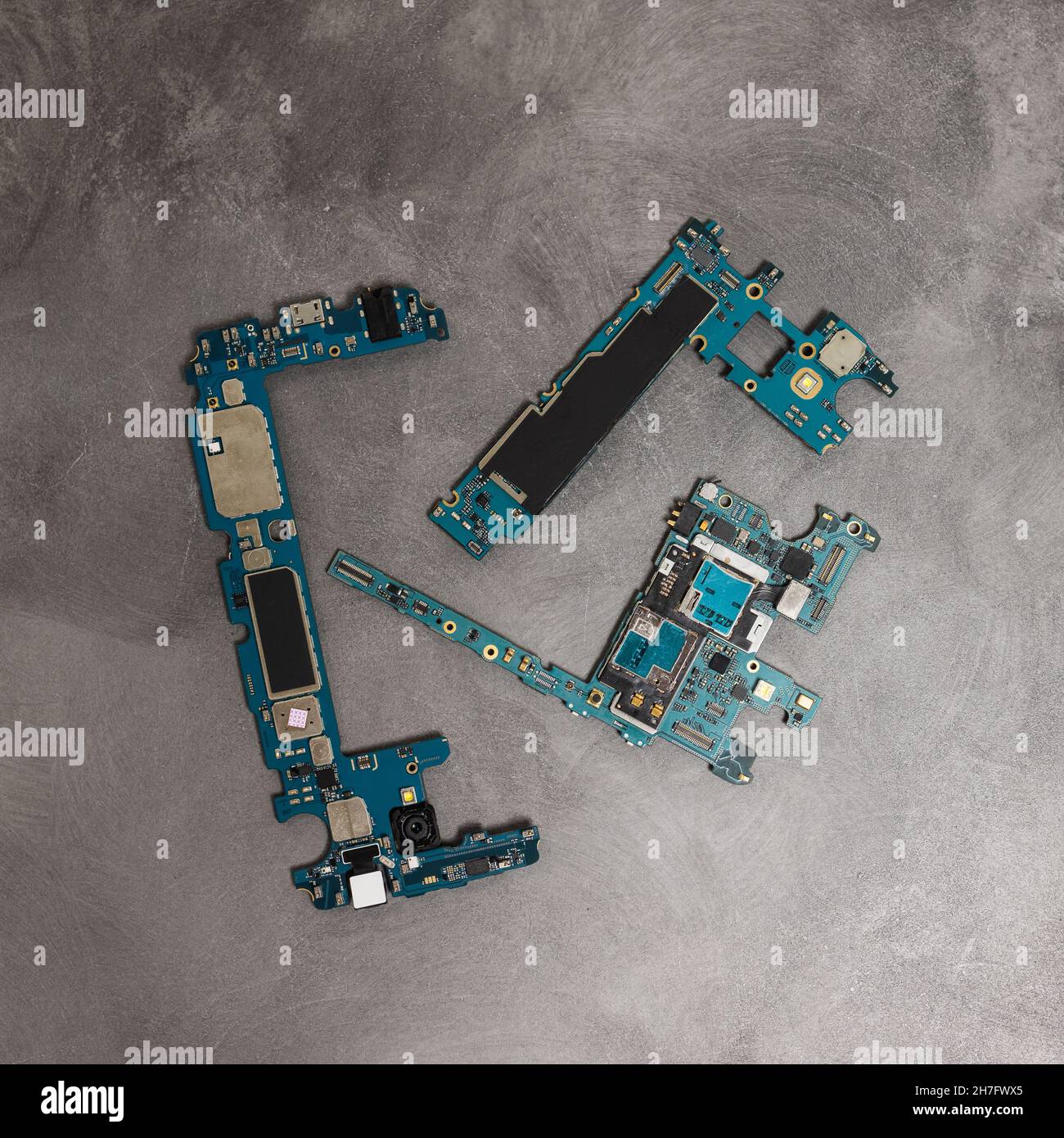 The inside of the smartphone's motherboard and tools lay on the back ...