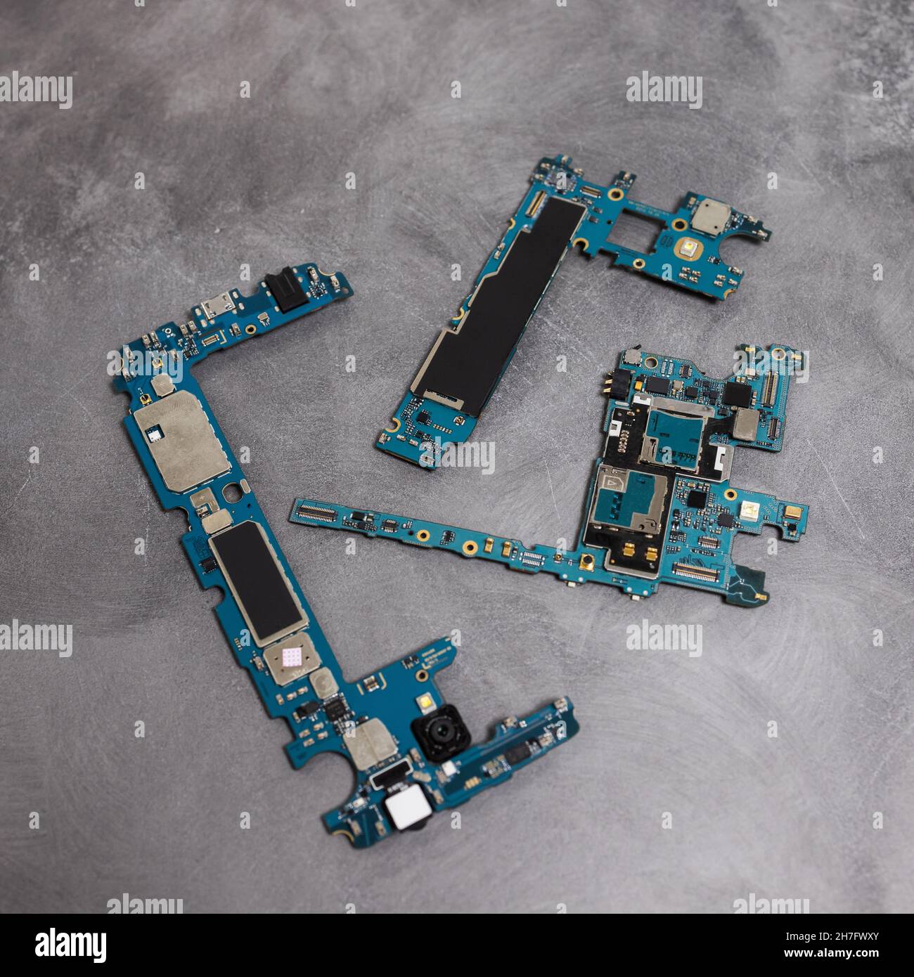 The inside of the smartphone's motherboard and tools lay on the back ...