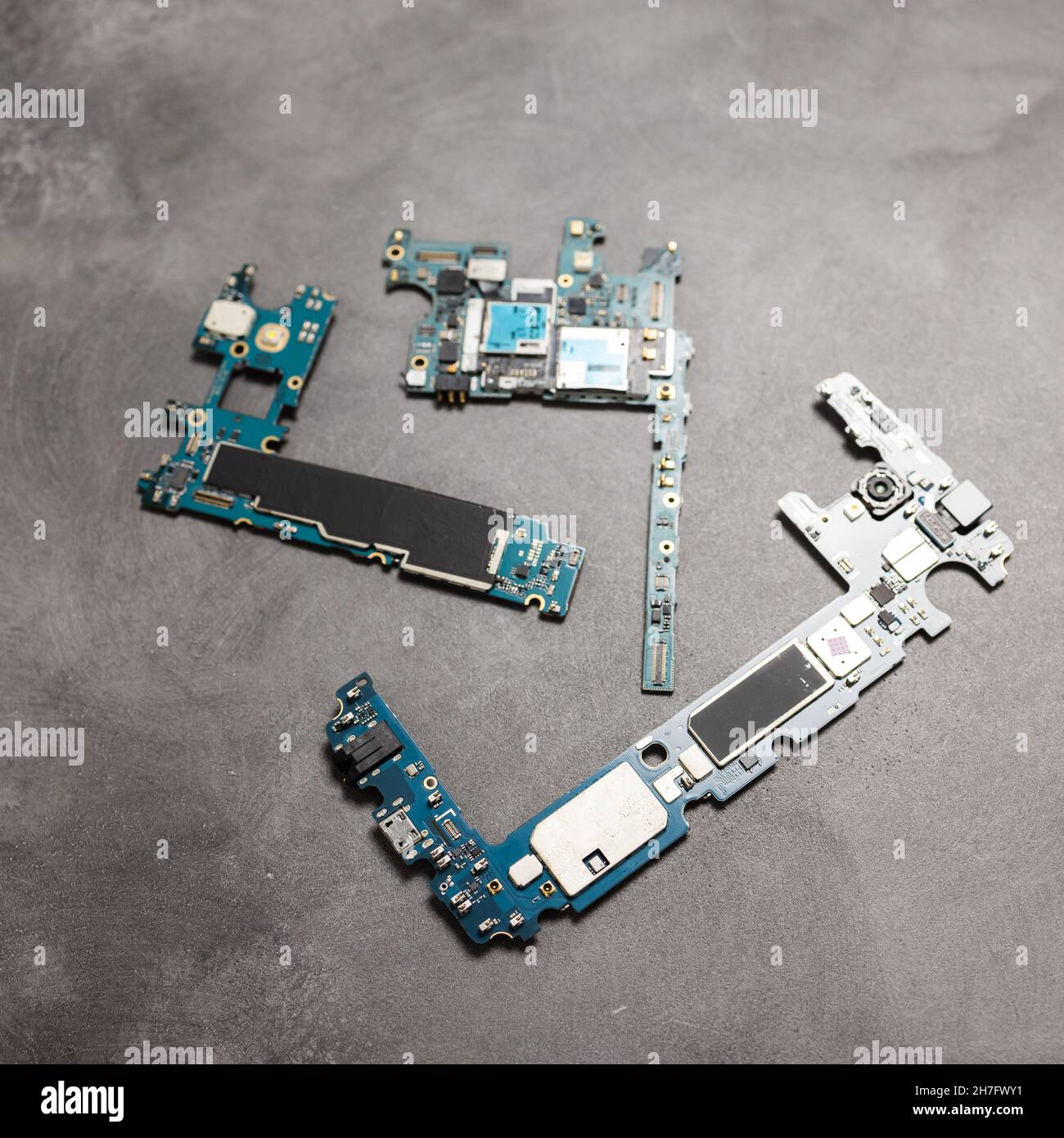 The inside of the smartphone's motherboard and tools lay on the back ...
