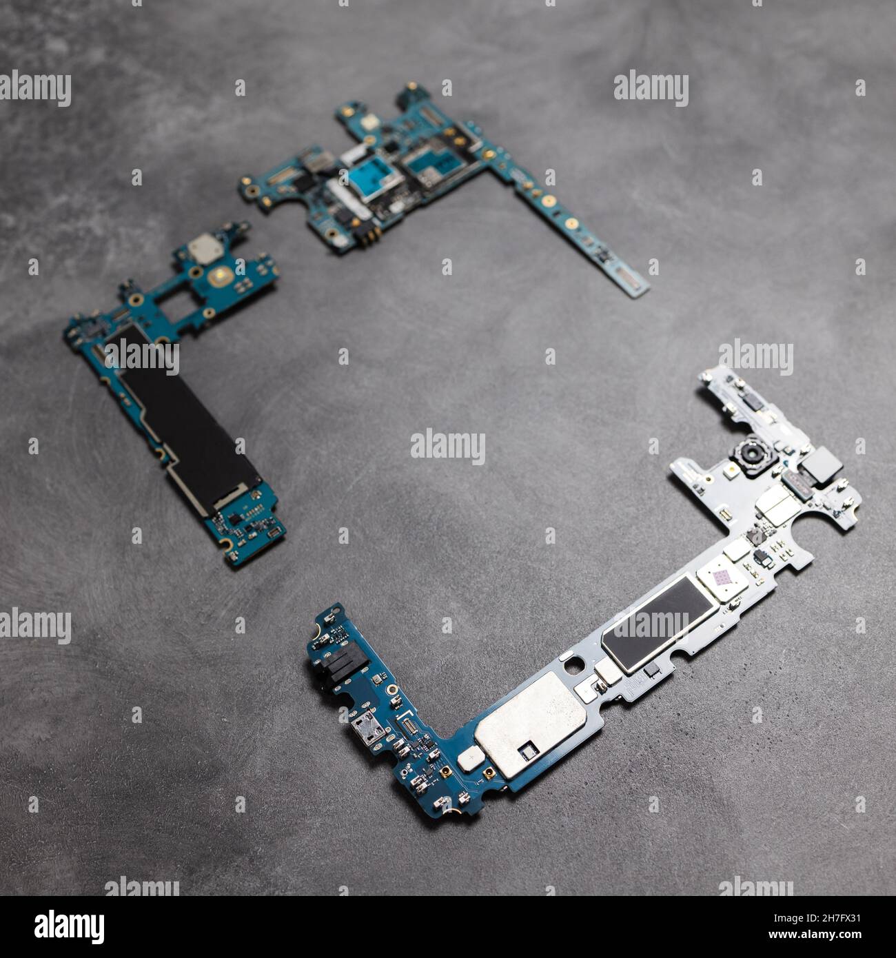 The inside of the smartphone's motherboard and tools lay on the back ...