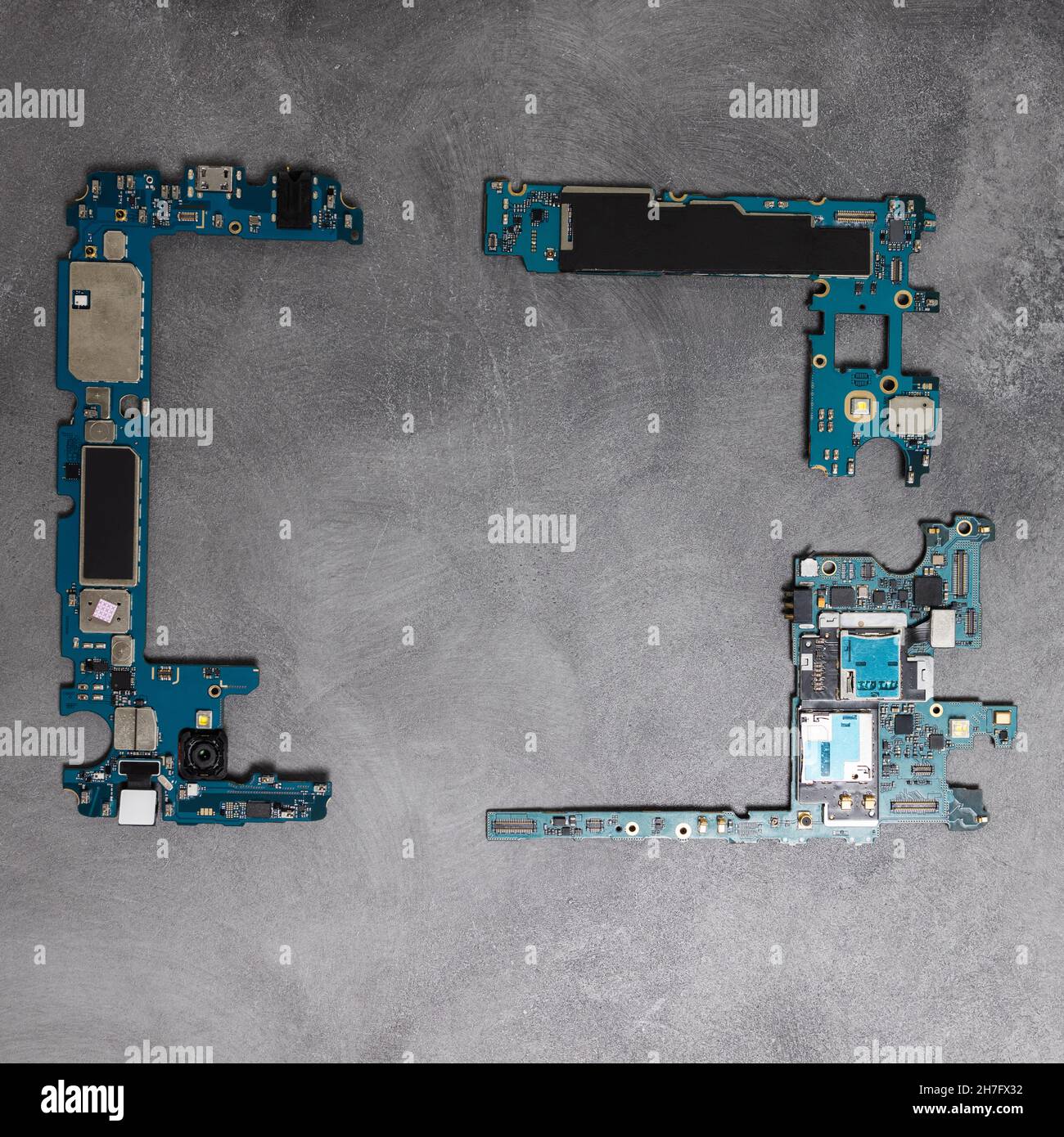 The inside of the smartphone's motherboard and tools lay on the back ...