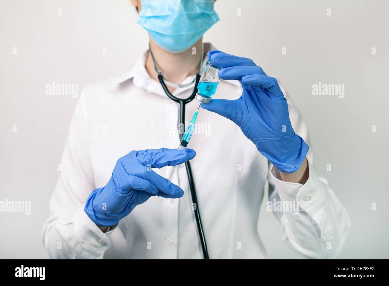 Selective focus shot of a doctor holding a syringe with vaccination ...