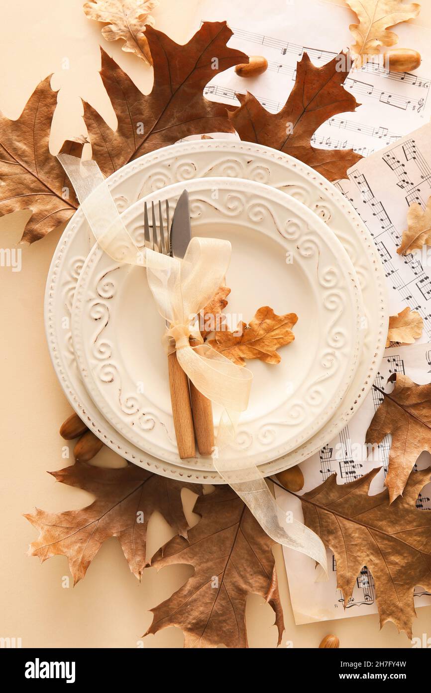 Autumn table setting and music notes on beige background Stock Photo ...