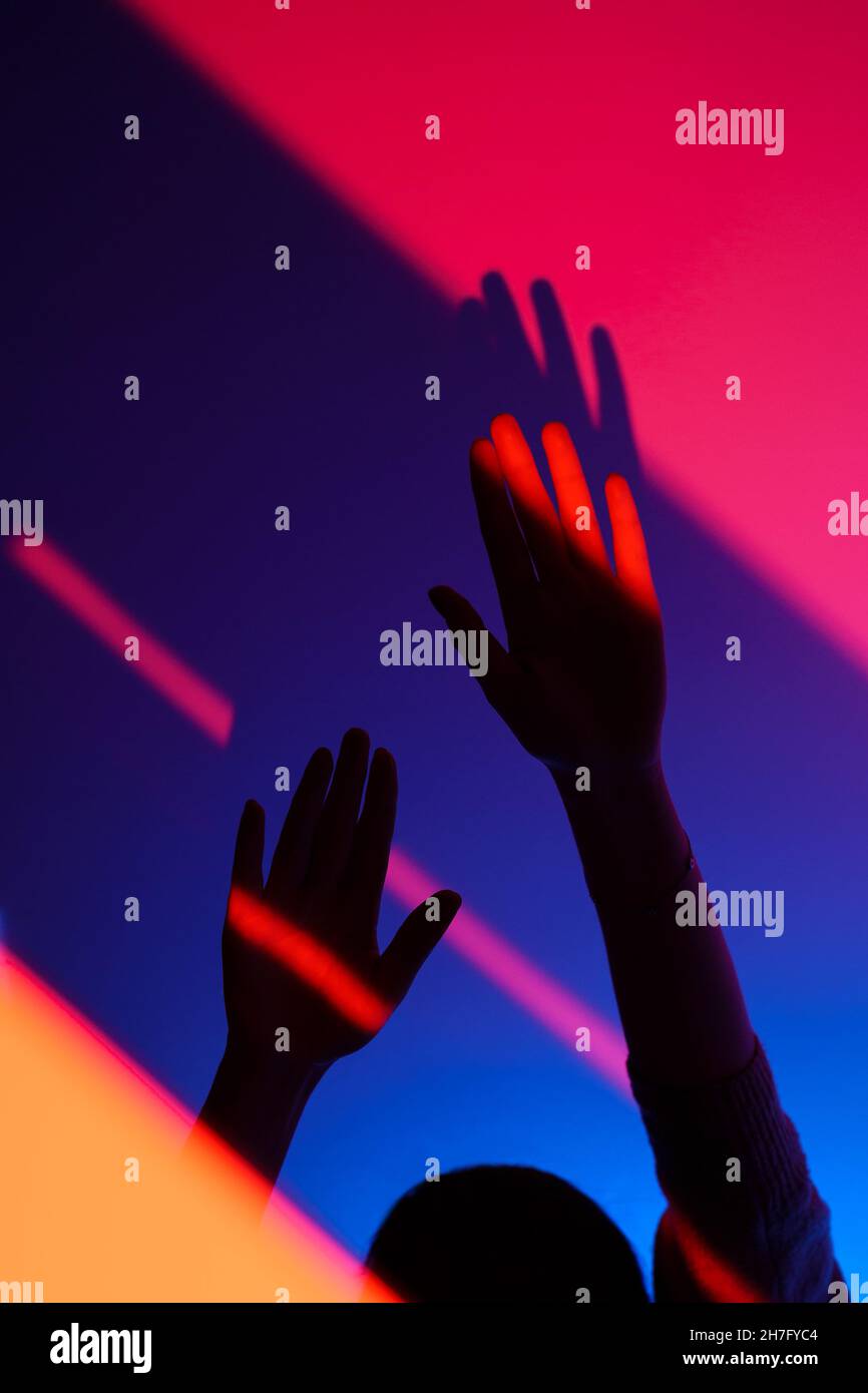 Woman arm gesturing with open hand over fashion blue, orange and pink ...