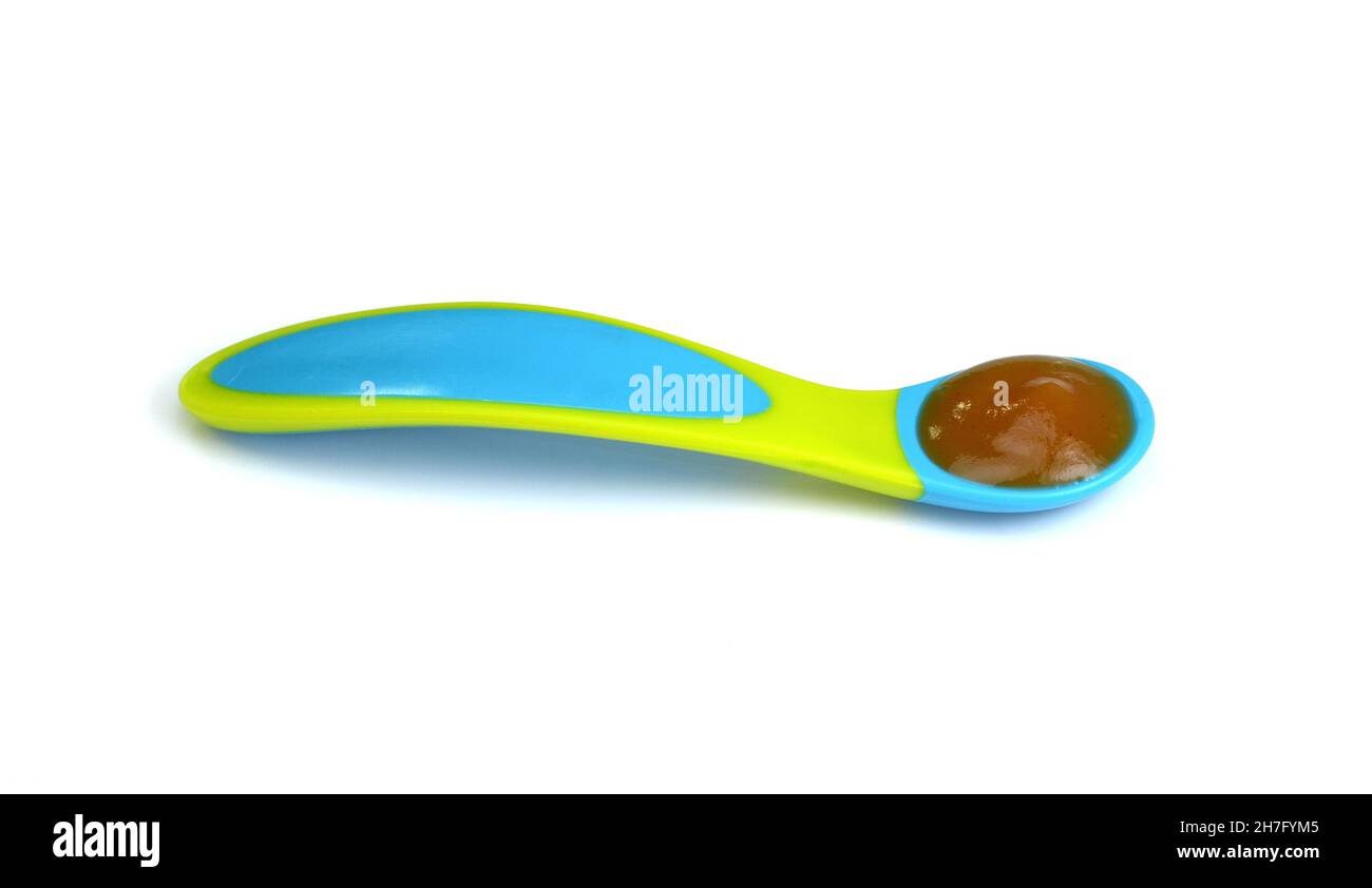 Baby fruit puree in spoon isolated on white Stock Photo - Alamy