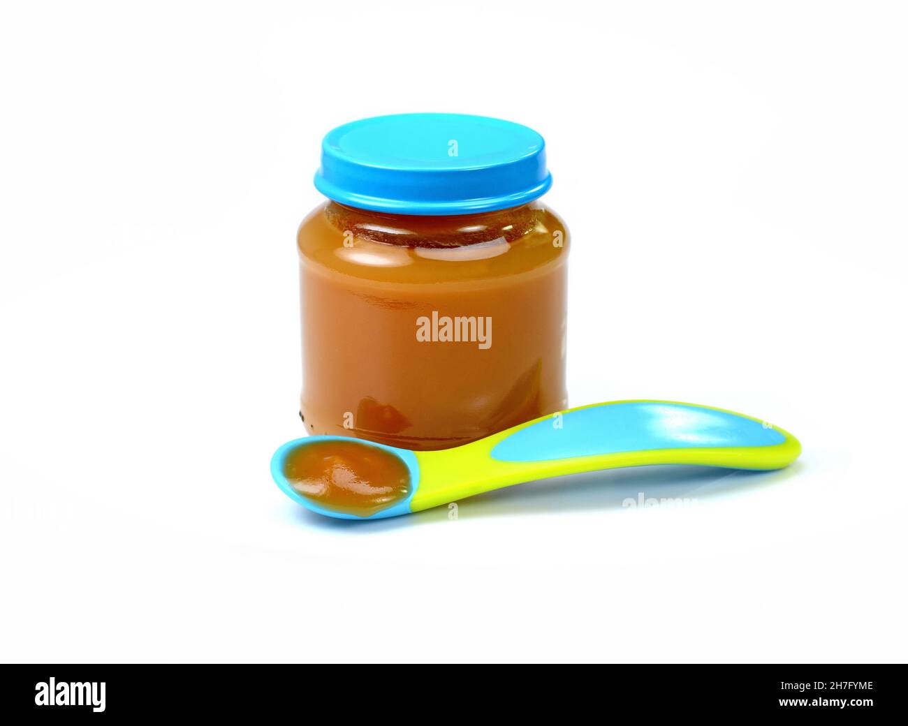 Baby fruit puree jar and spoon isolated on white Stock Photo - Alamy