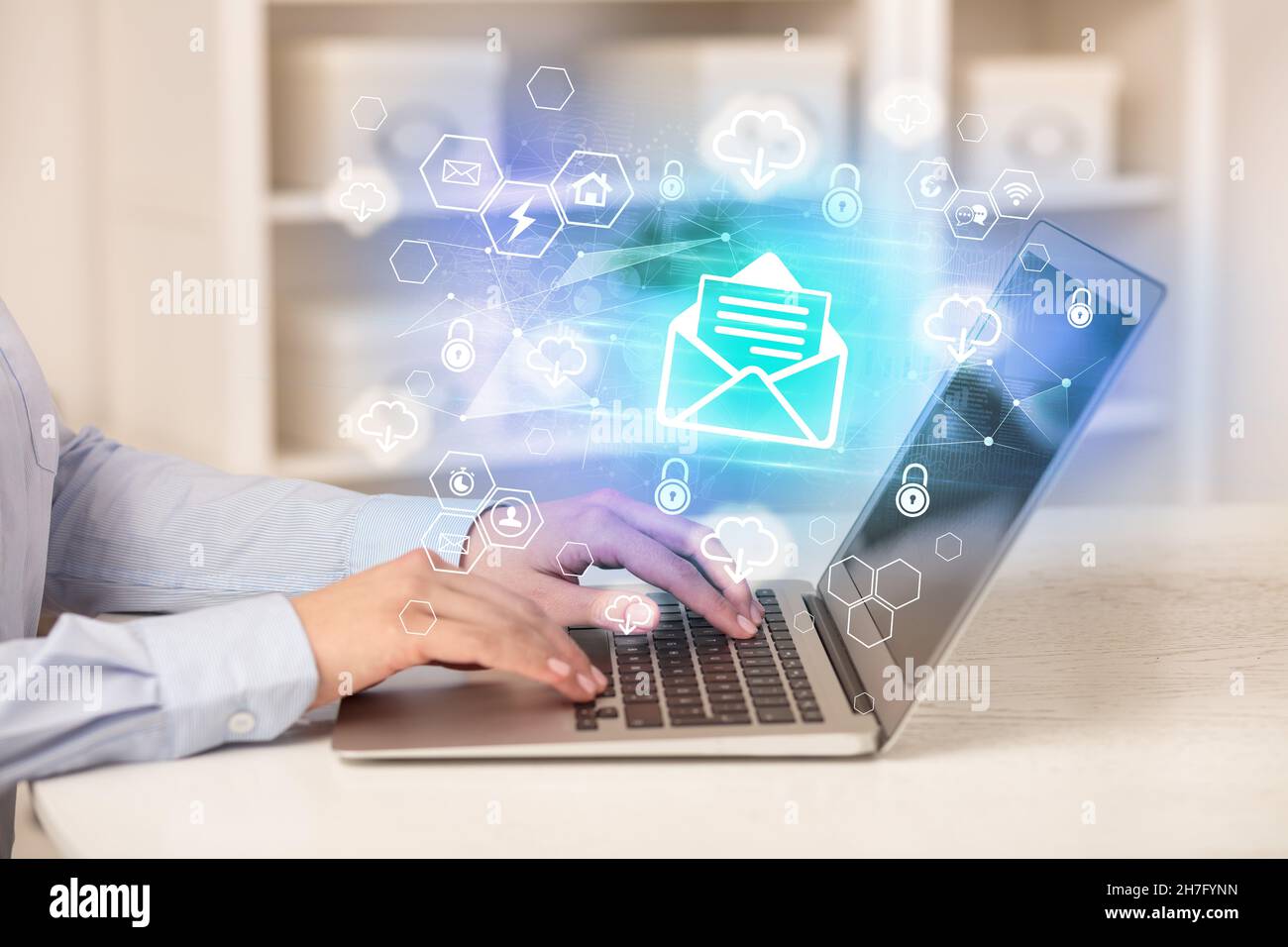 Hands working on laptop with digital icons Stock Photo - Alamy