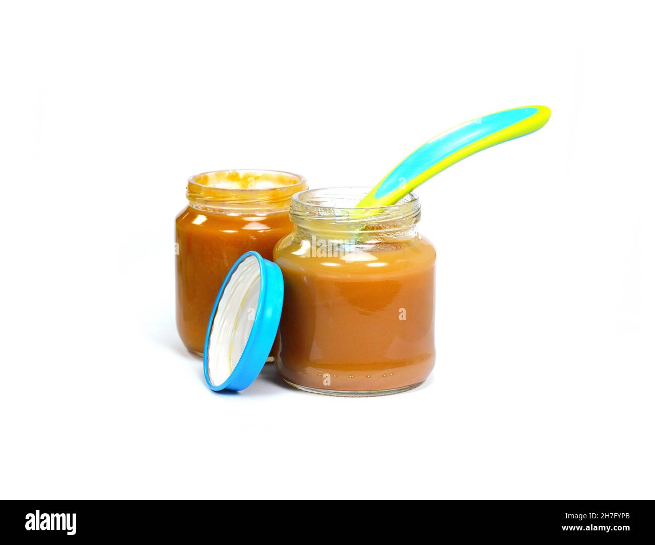 Baby fruit puree jar and spoon isolated on white Stock Photo - Alamy