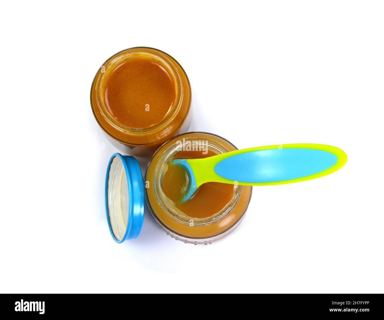 Baby fruit puree jar and spoon isolated on white Stock Photo - Alamy
