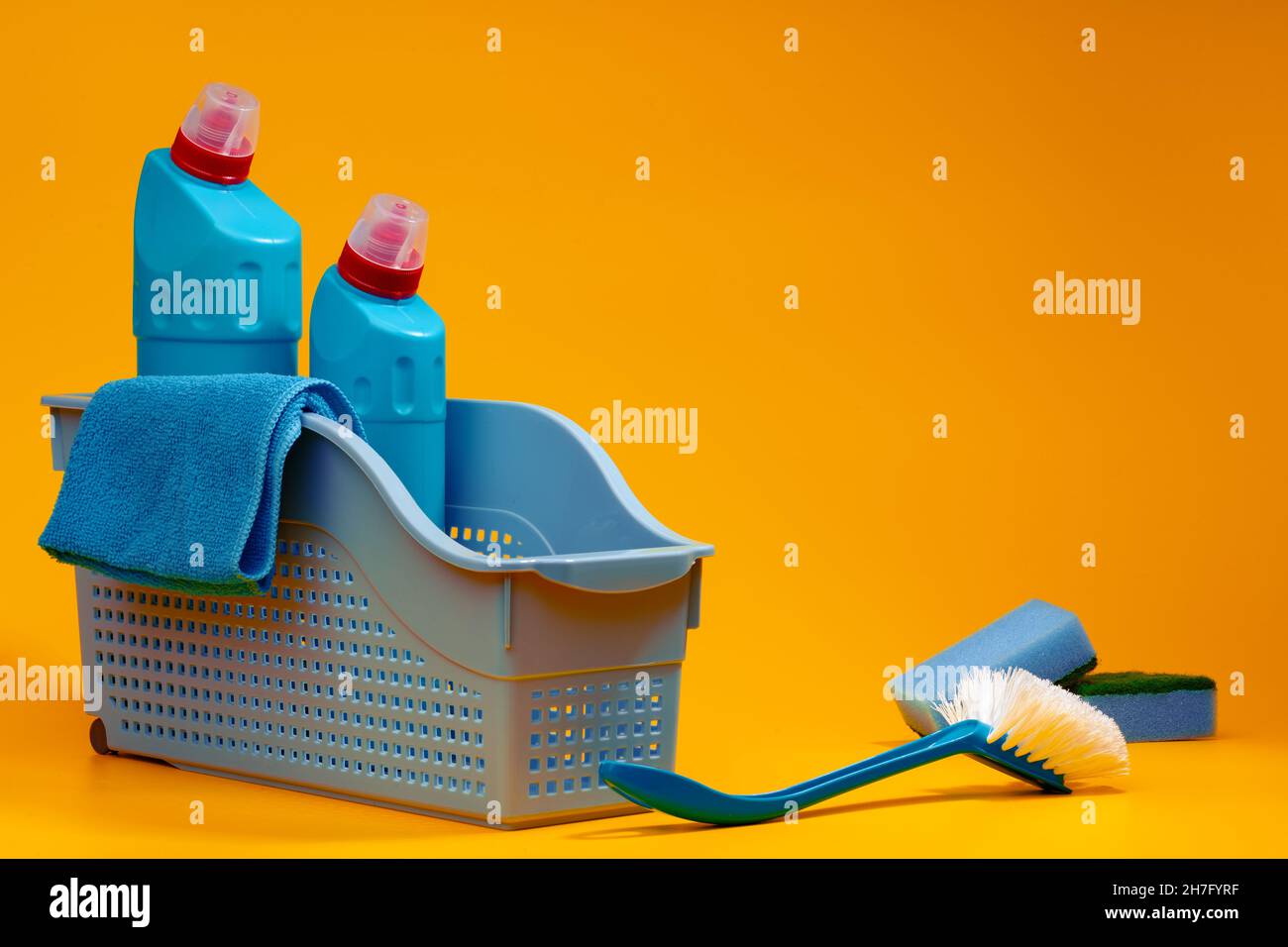 Home cleaning tools on yellow studio background Stock Photo - Alamy