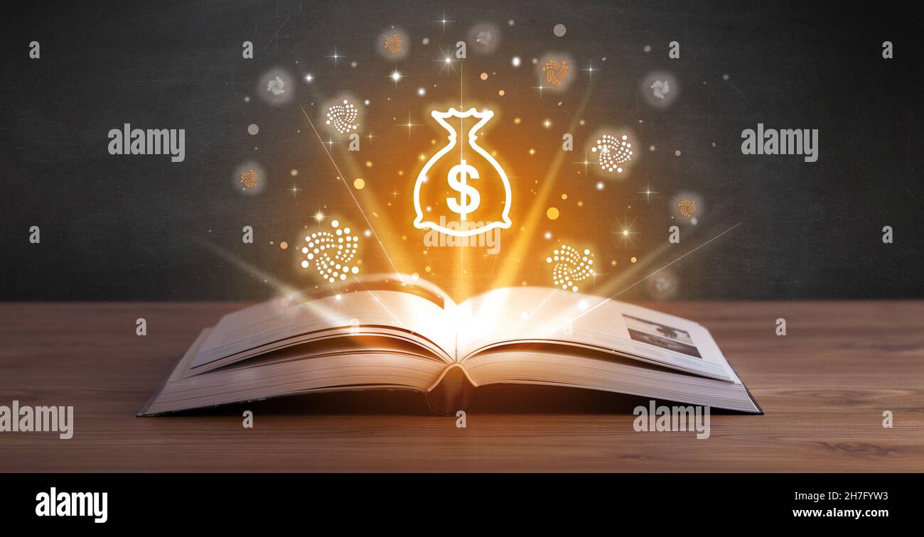Open book with currency icons above Stock Photo - Alamy