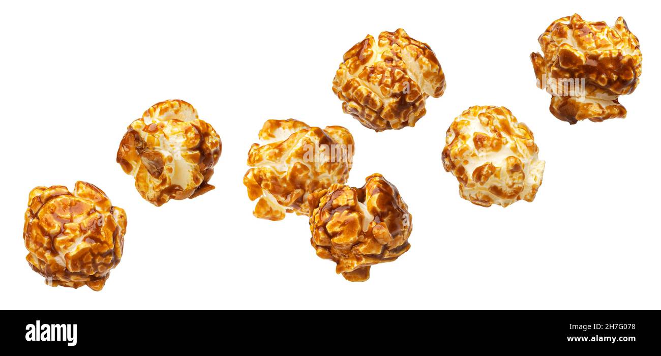 Falling caramel popcorn isolated on white background Stock Photo - Alamy