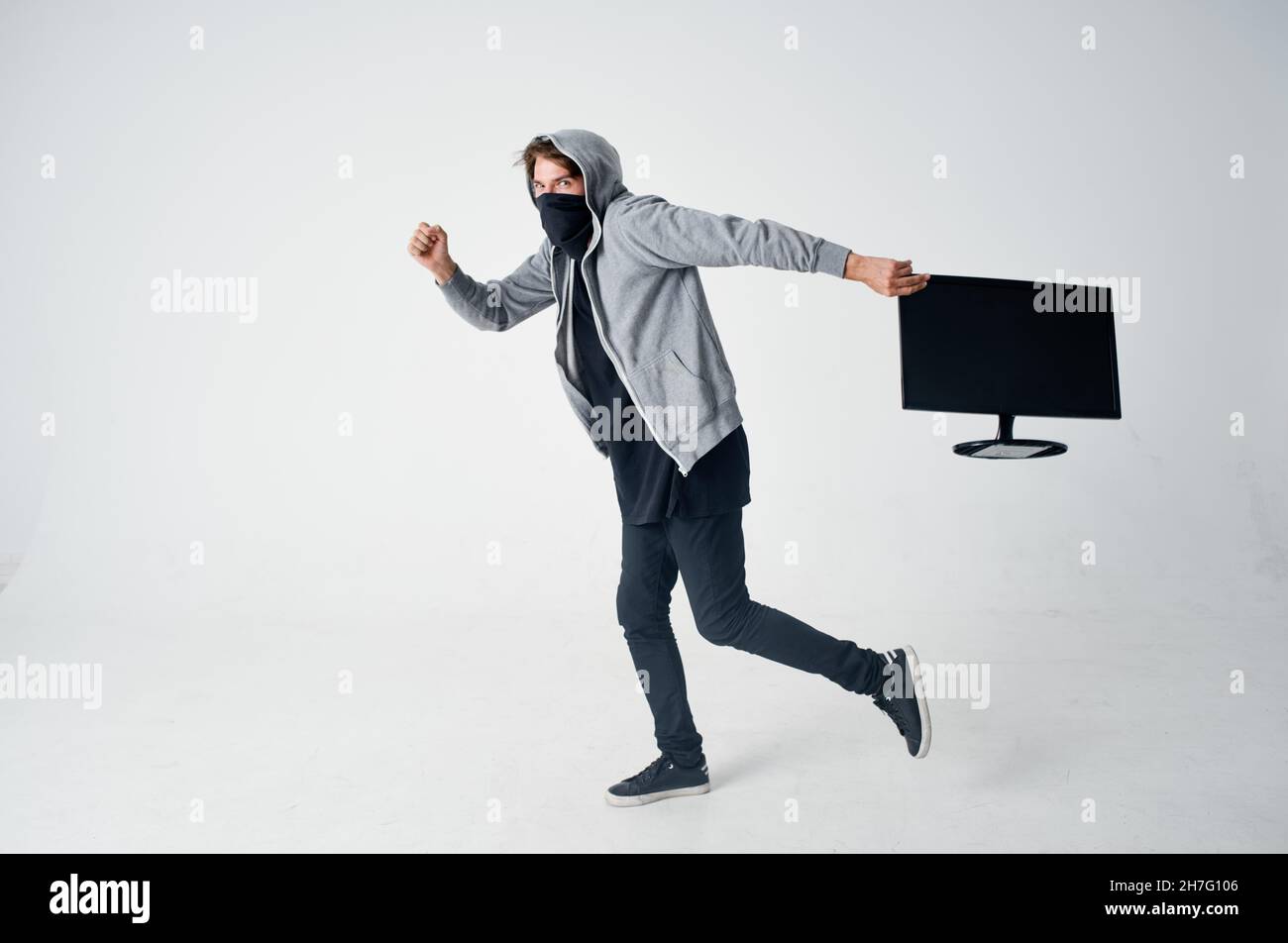 masked man hooded head hacking technology security light background Stock Photo - Alamy